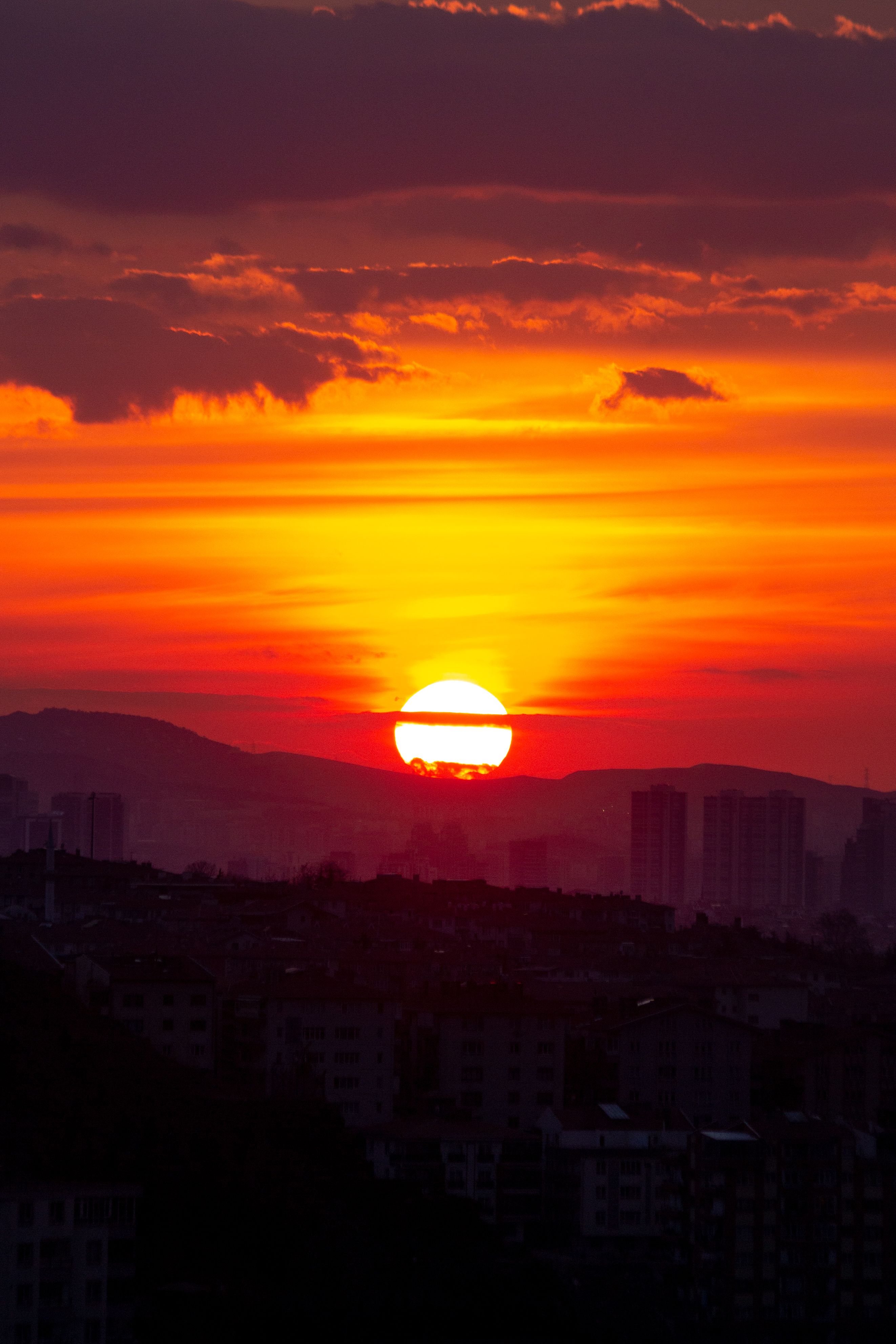 A Silhouetted Urban Skyline at Sunset · Free Stock Photo