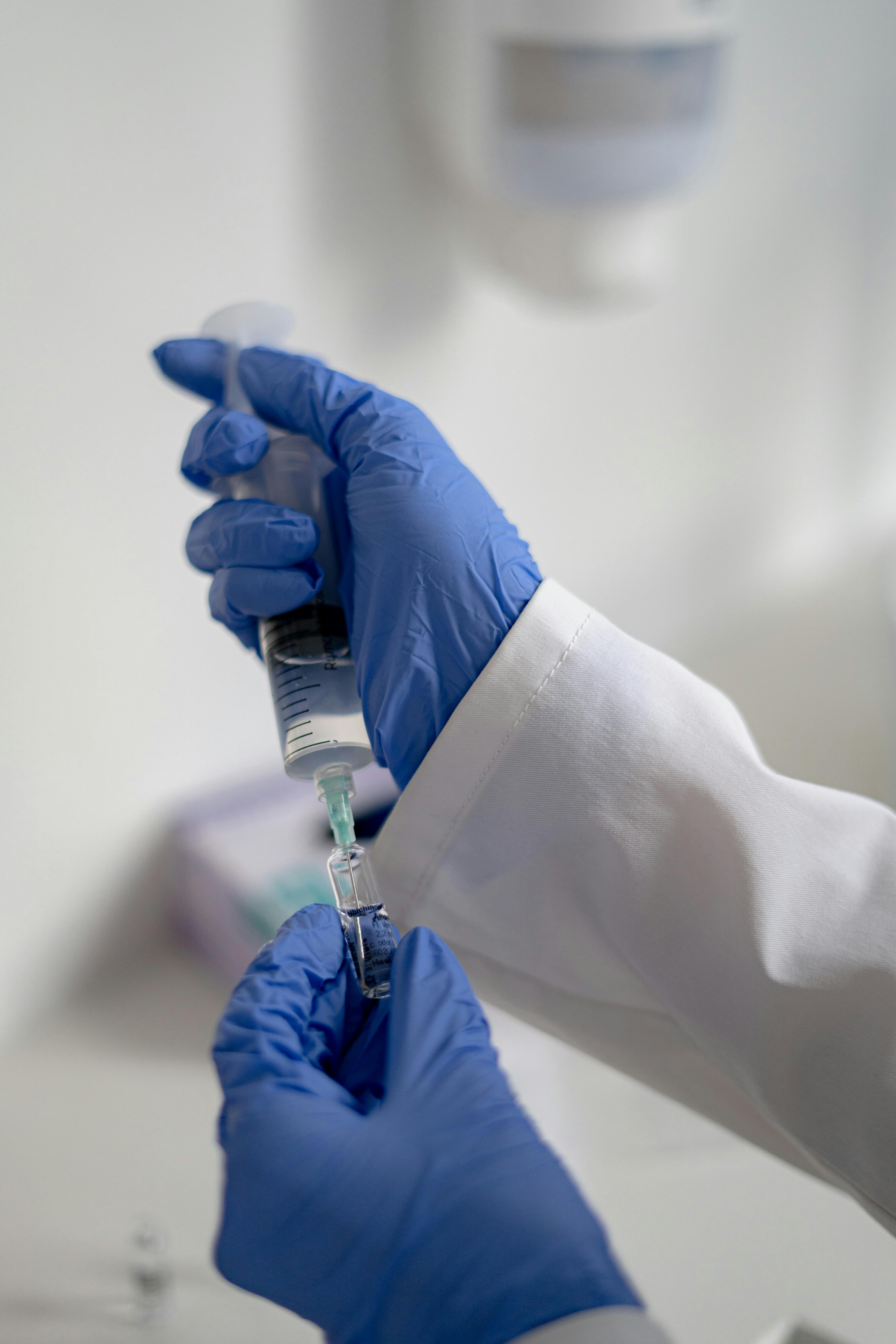 Pouring from Vial to Test Tube · Free Stock Photo