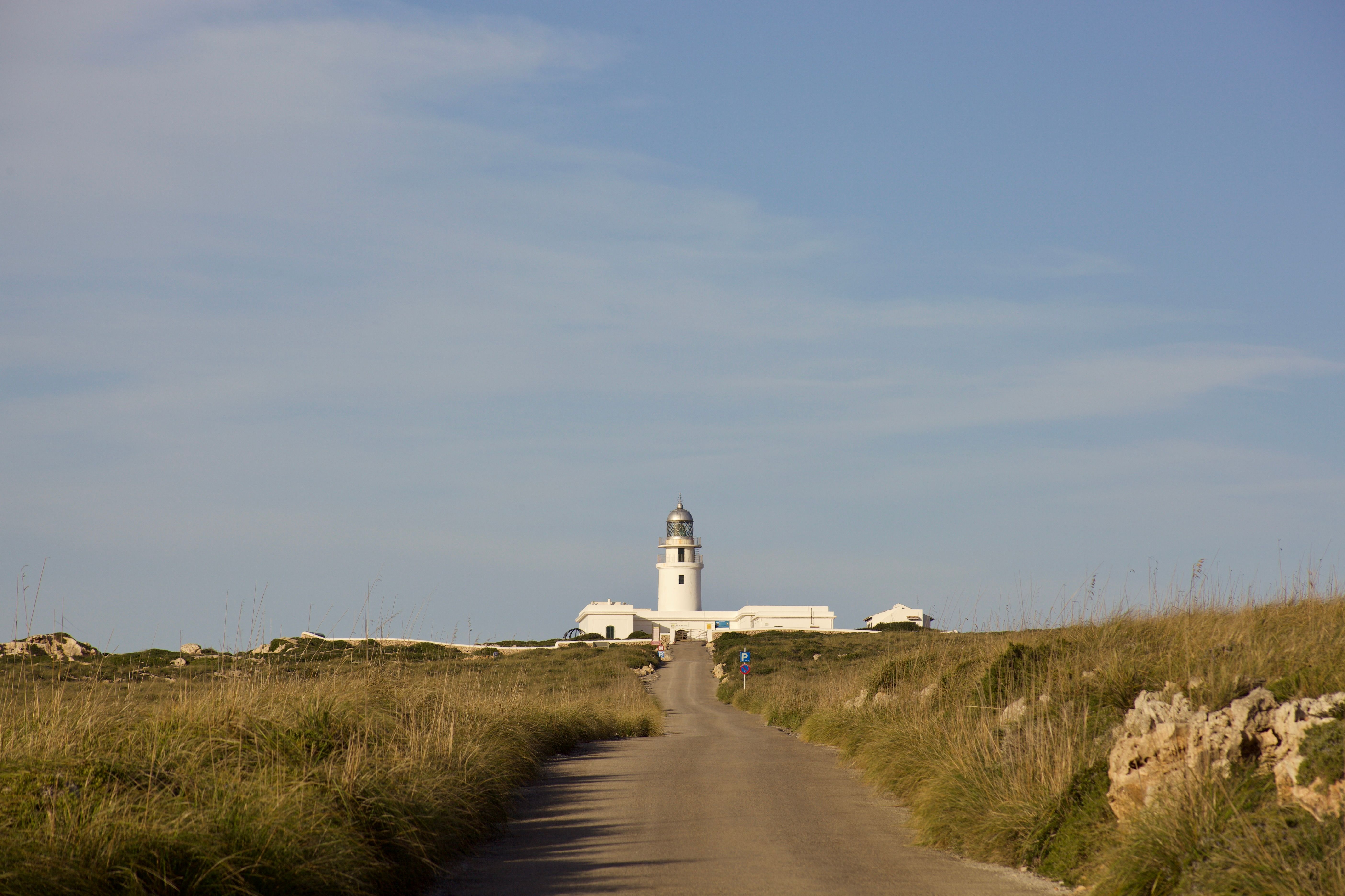 Road and a Lighthouse in the Distance · Free Stock Photo