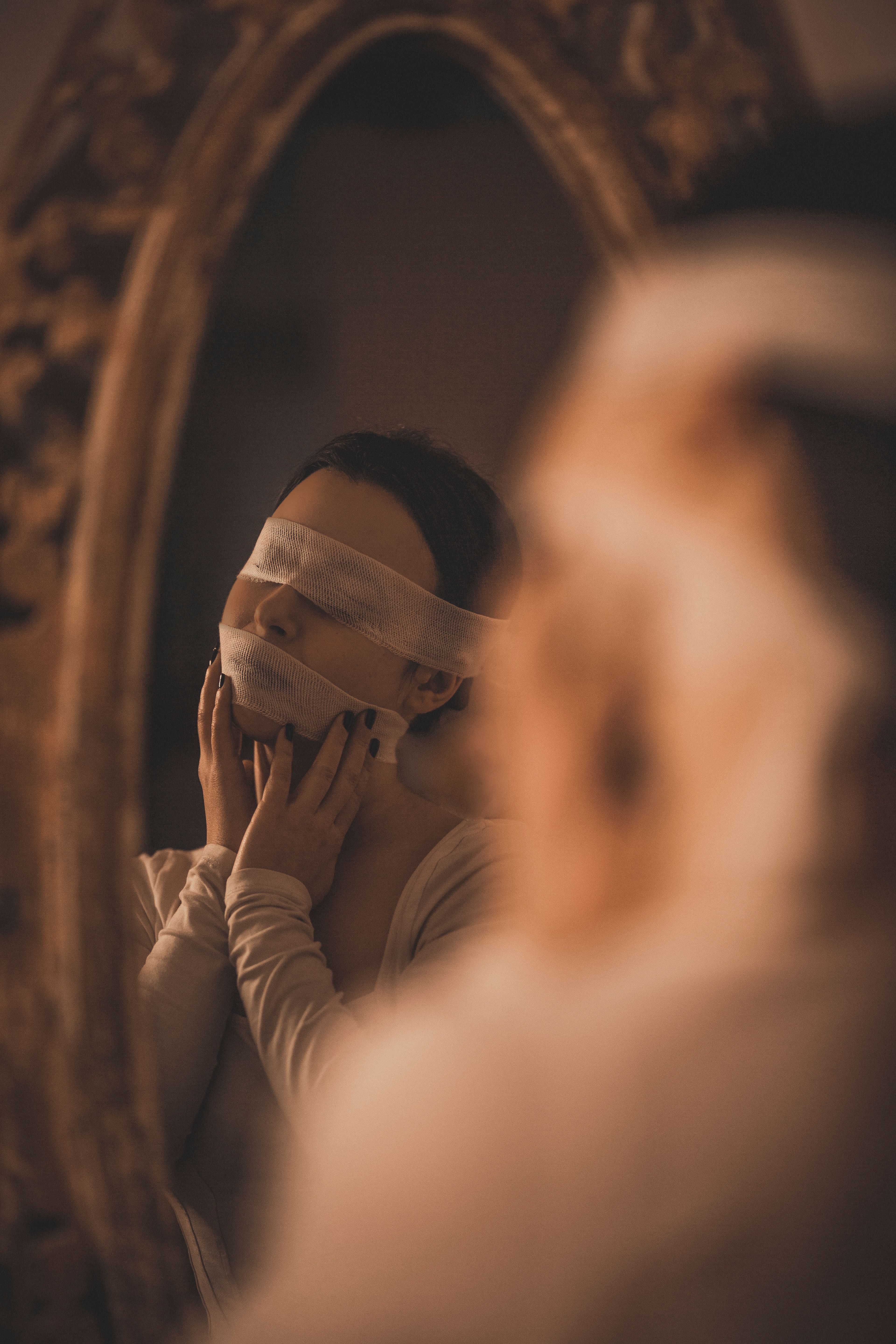 Womans Shoulder and Face in Mirror Reflection · Free Stock Photo