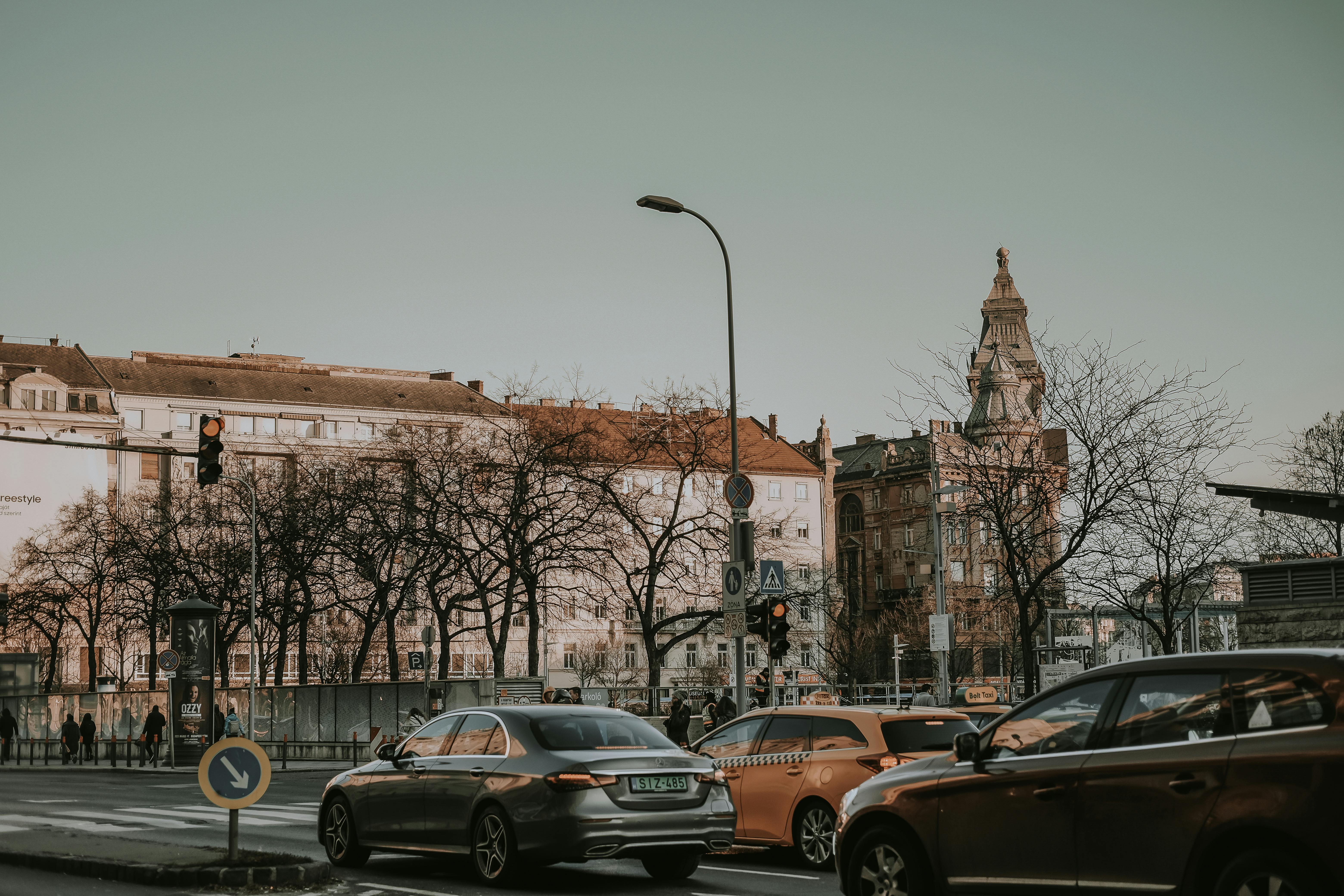 Cars are parked on the street in front of a building · Free Stock Photo