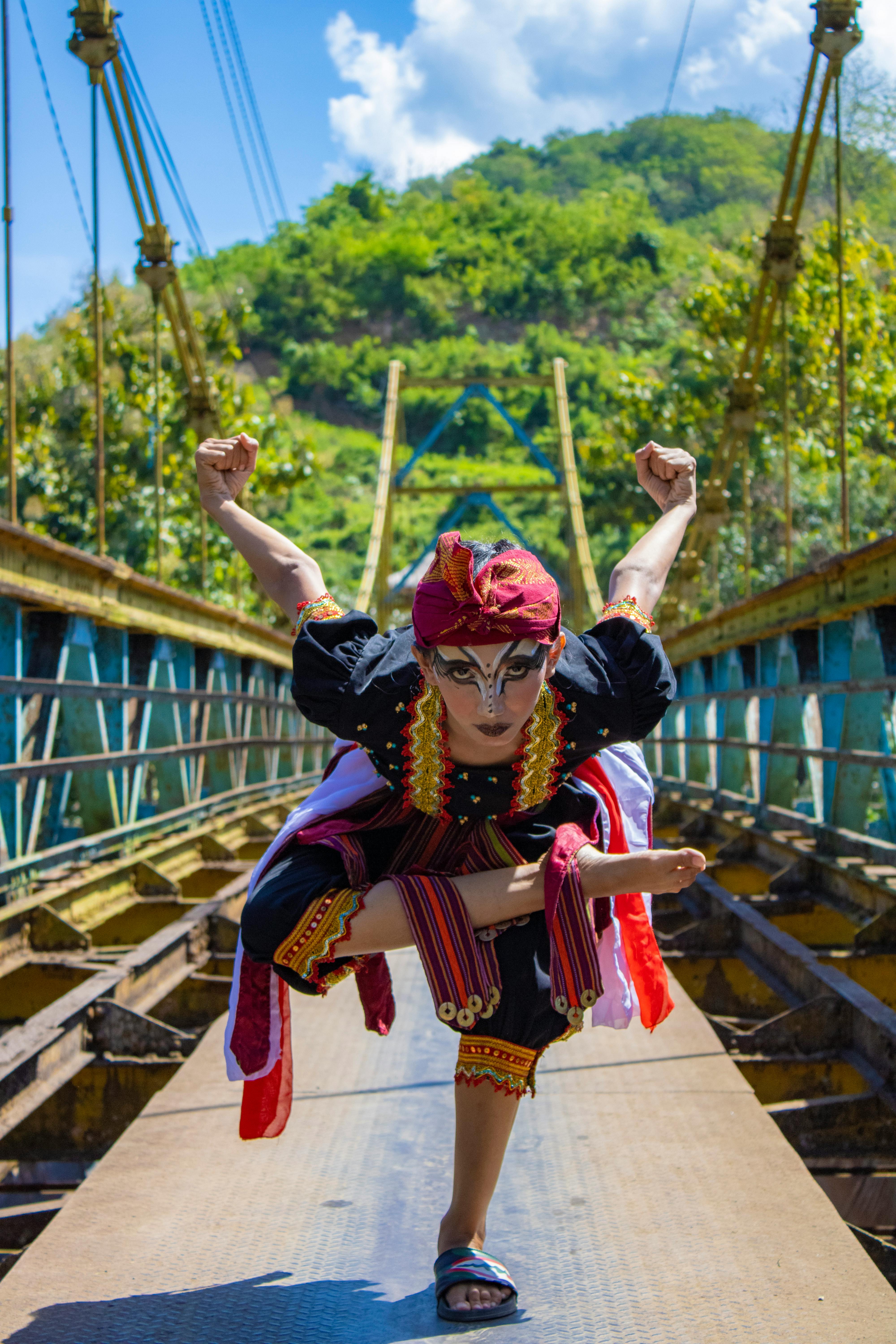 Woman in Traditional Clothing Posing on Bridge · Free Stock Photo