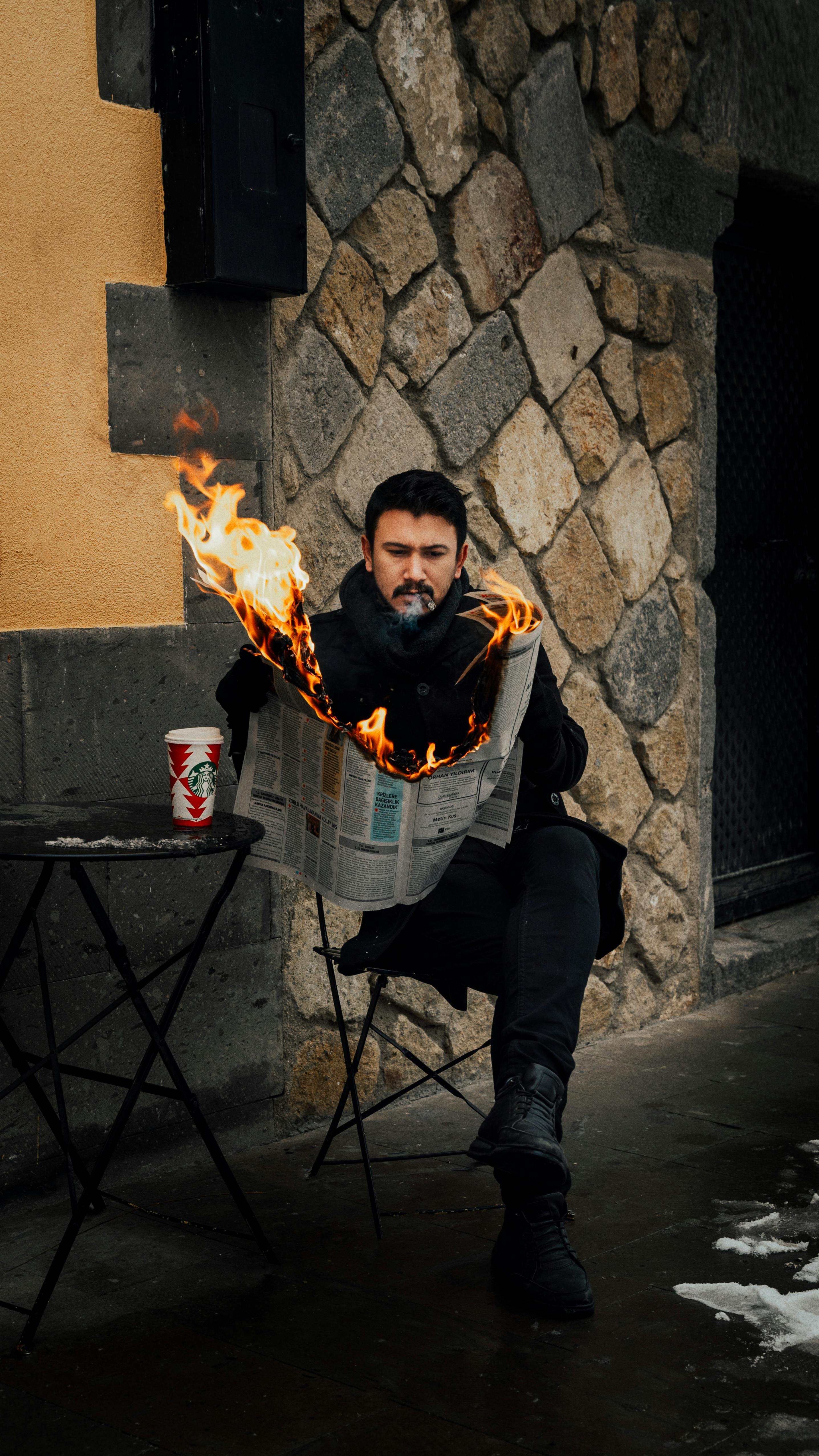 Man Holding Burning Newspaper · Free Stock Photo