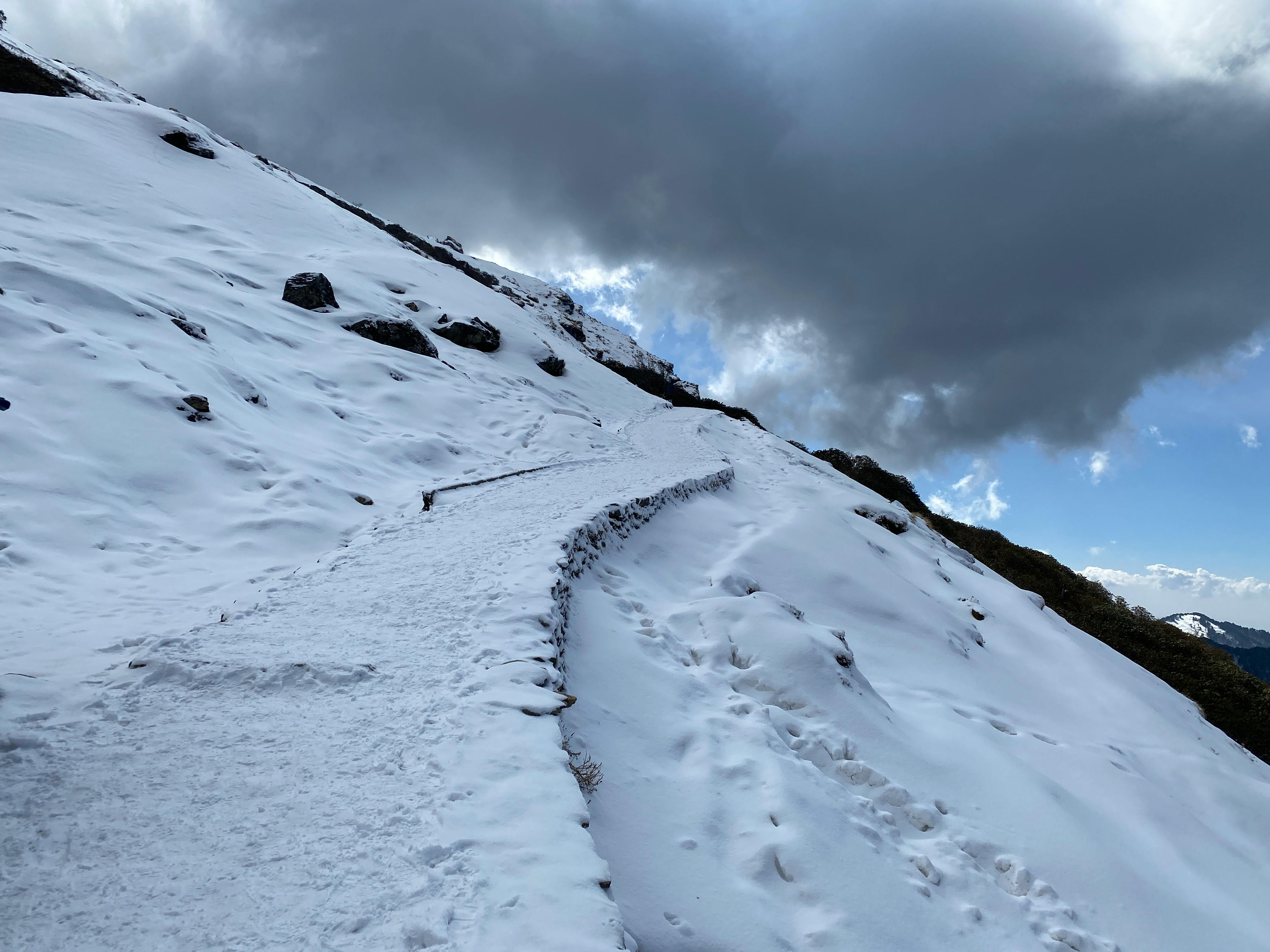Person Walking on Snow Covered Ground · Free Stock Photo
