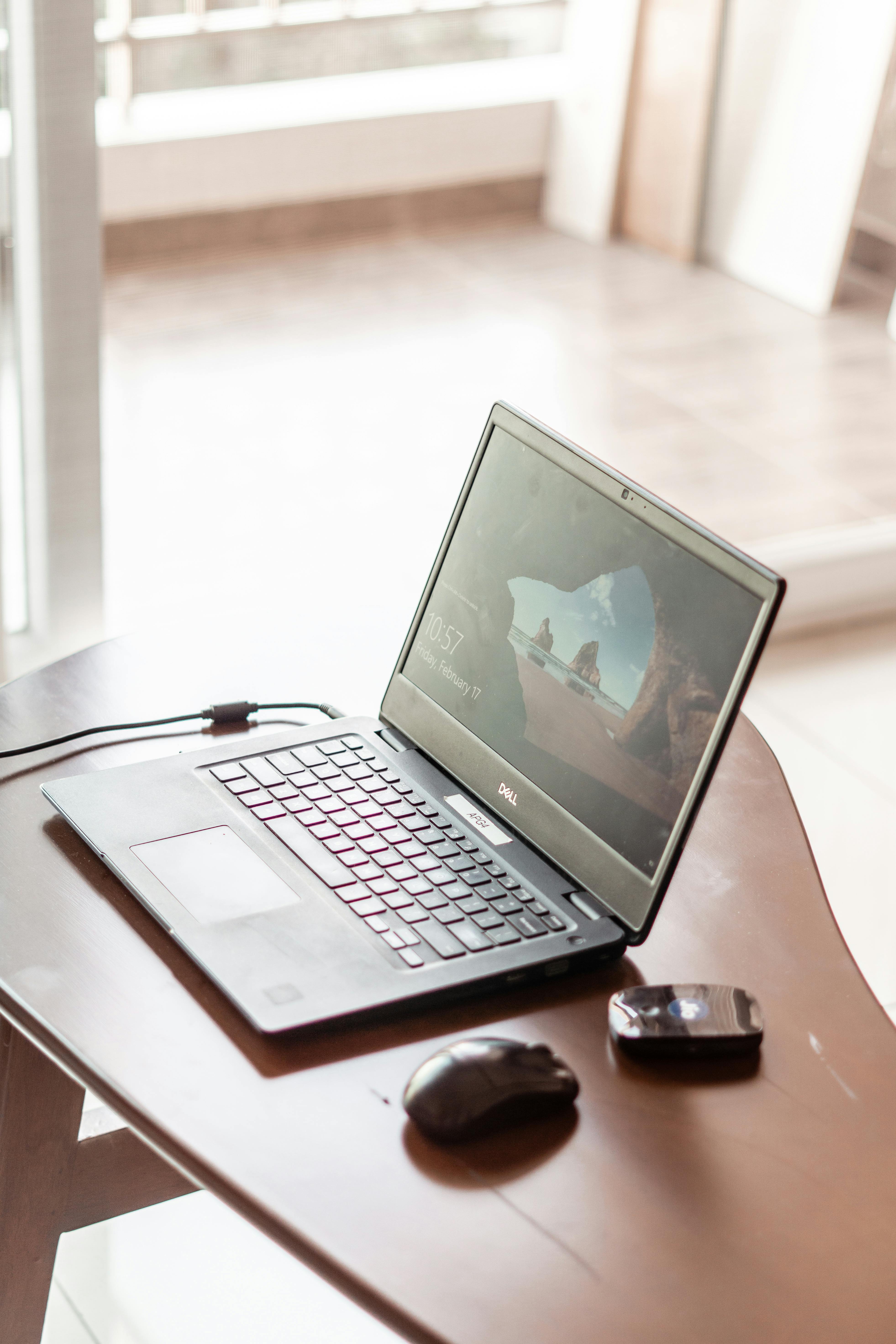 White Wooden Table with Computer Under the Bookshelf · Free Stock Photo