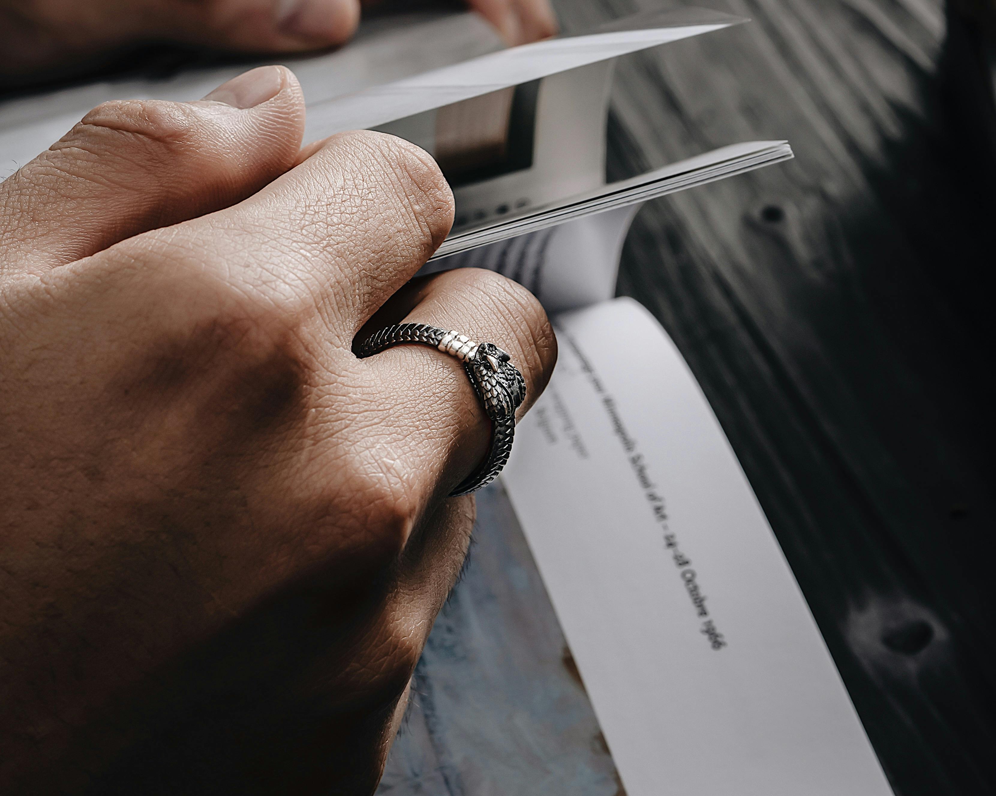 Ring on Hand Holding Book · Free Stock Photo