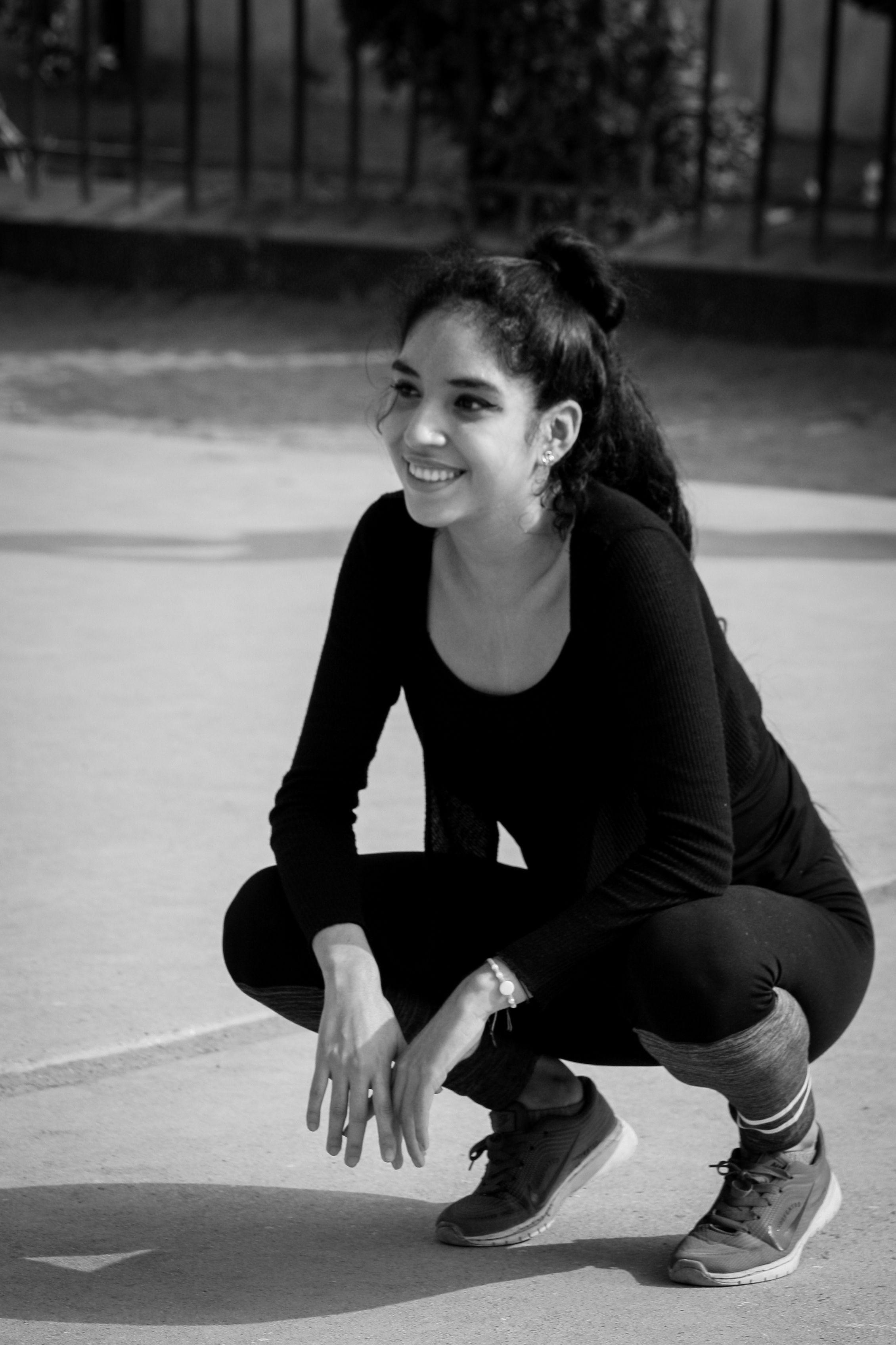 Woman Crouching and Playing with her Shadow on the Wall · Free Stock Photo