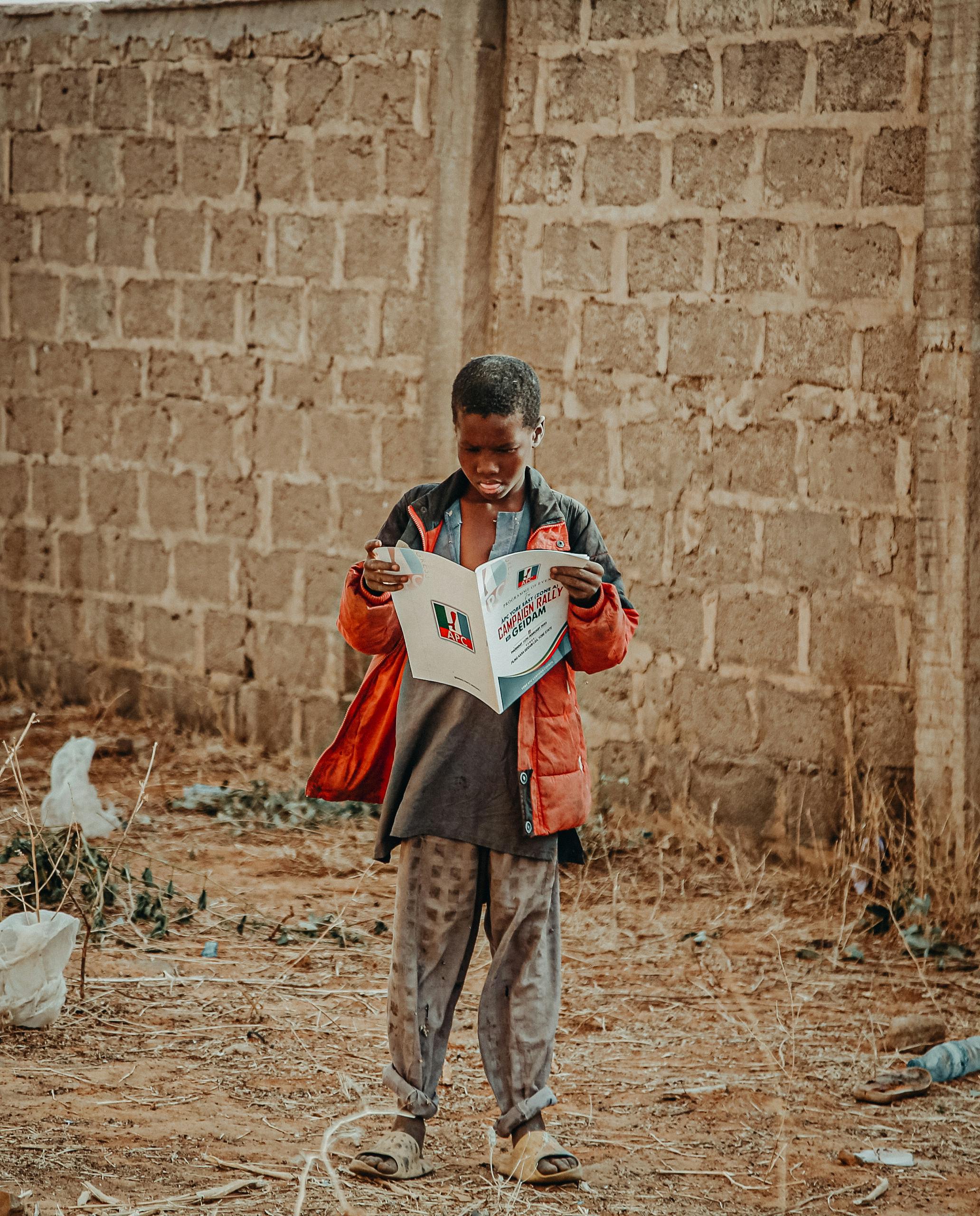 Boy Reading a Newspaper · Free Stock Photo