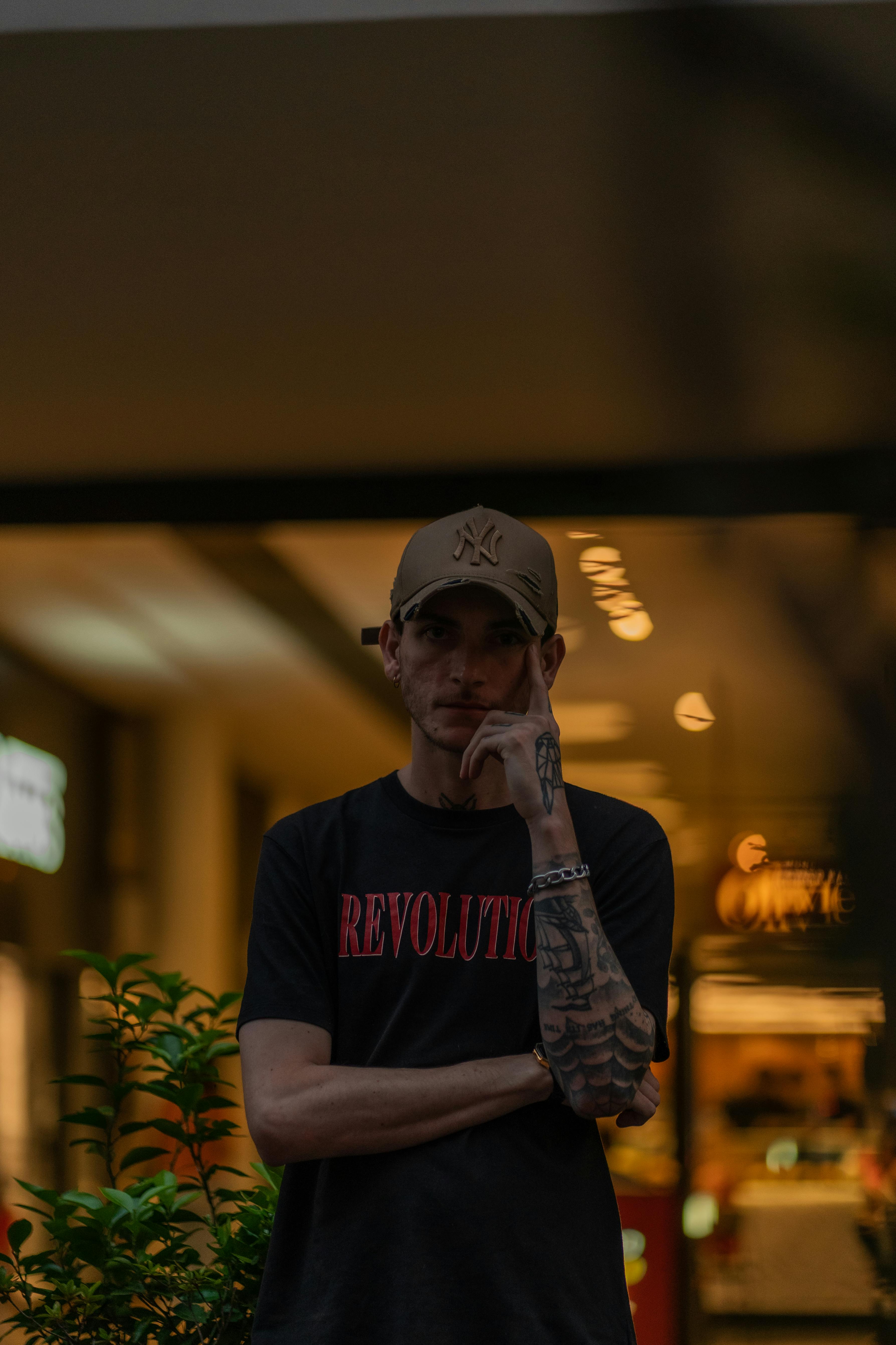Man Posing in Cap and T-shirt · Free Stock Photo