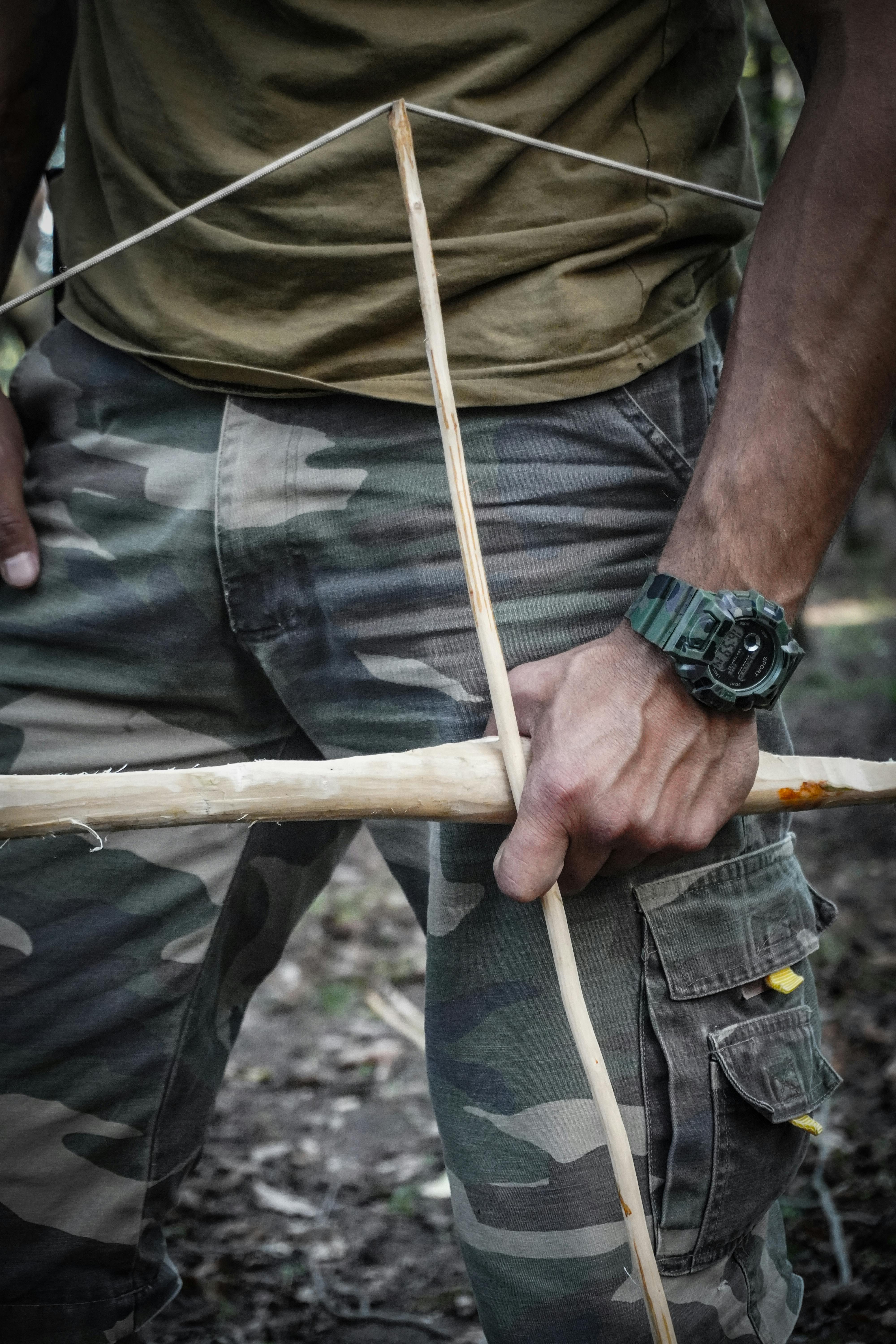 A man holding a bow and arrow in his hands · Free Stock Photo