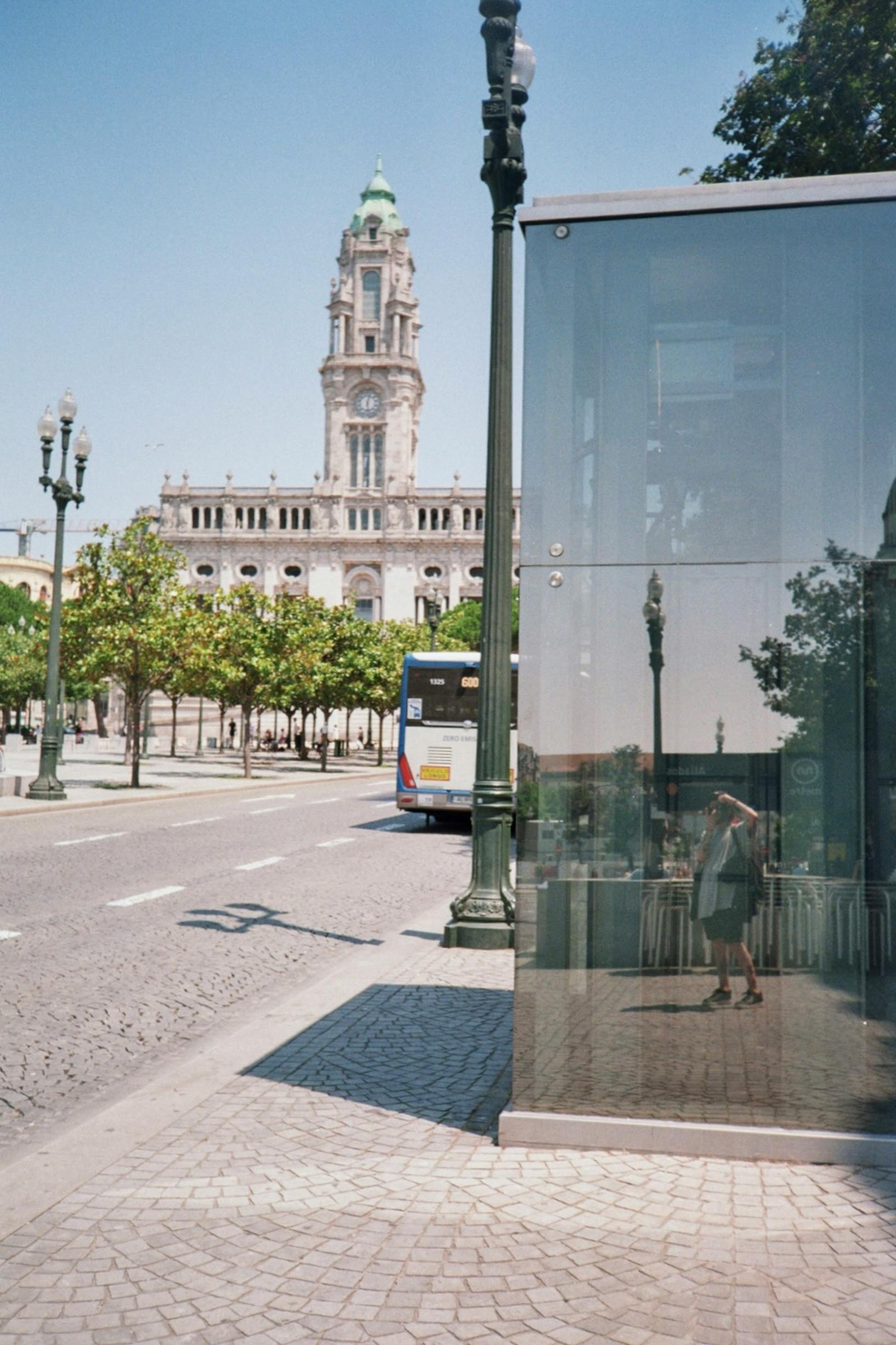 A bus stop with a reflection of a building · Free Stock Photo