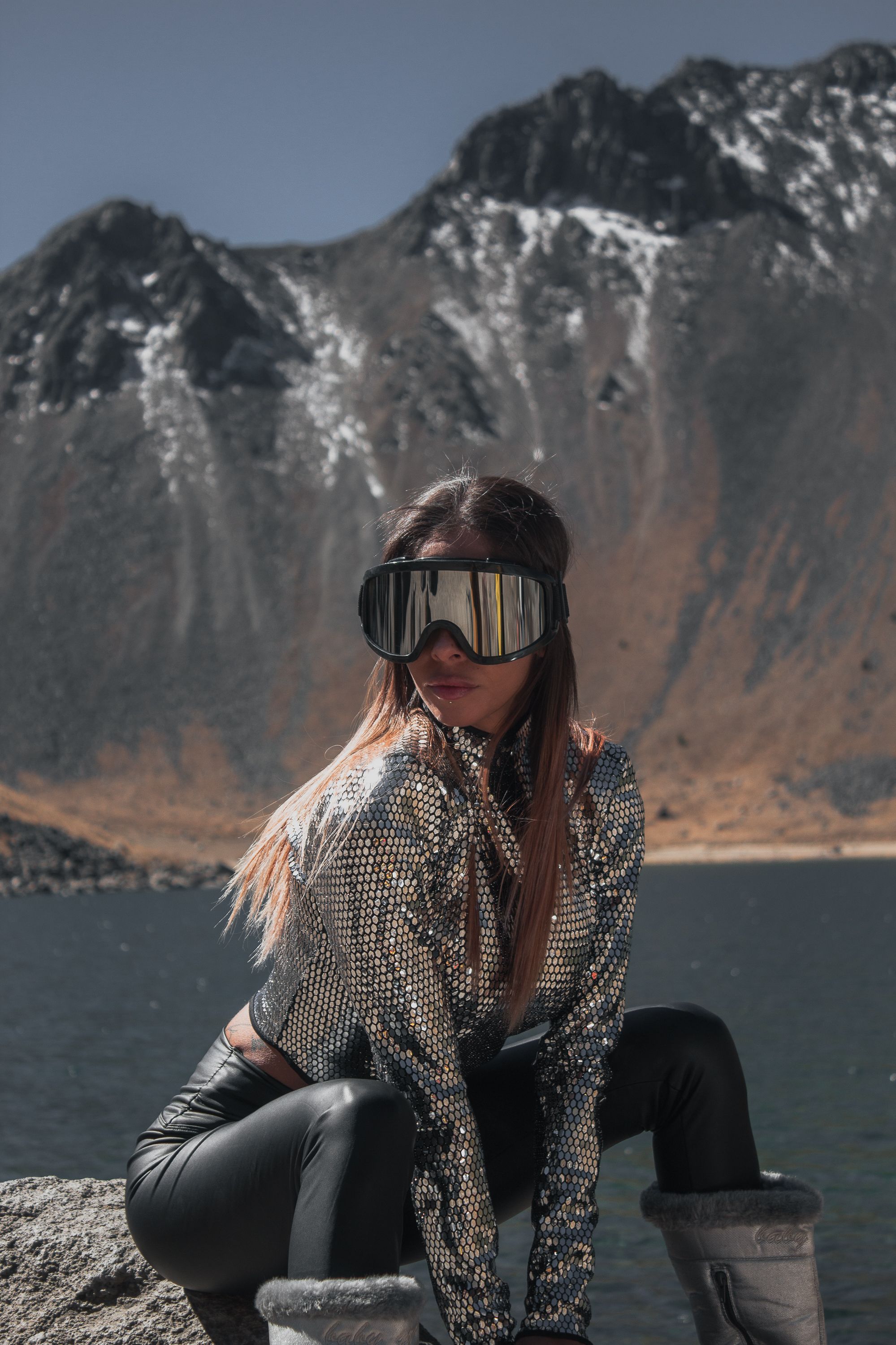 Woman in Goggles Posing by Lake in Mountains · Free Stock Photo