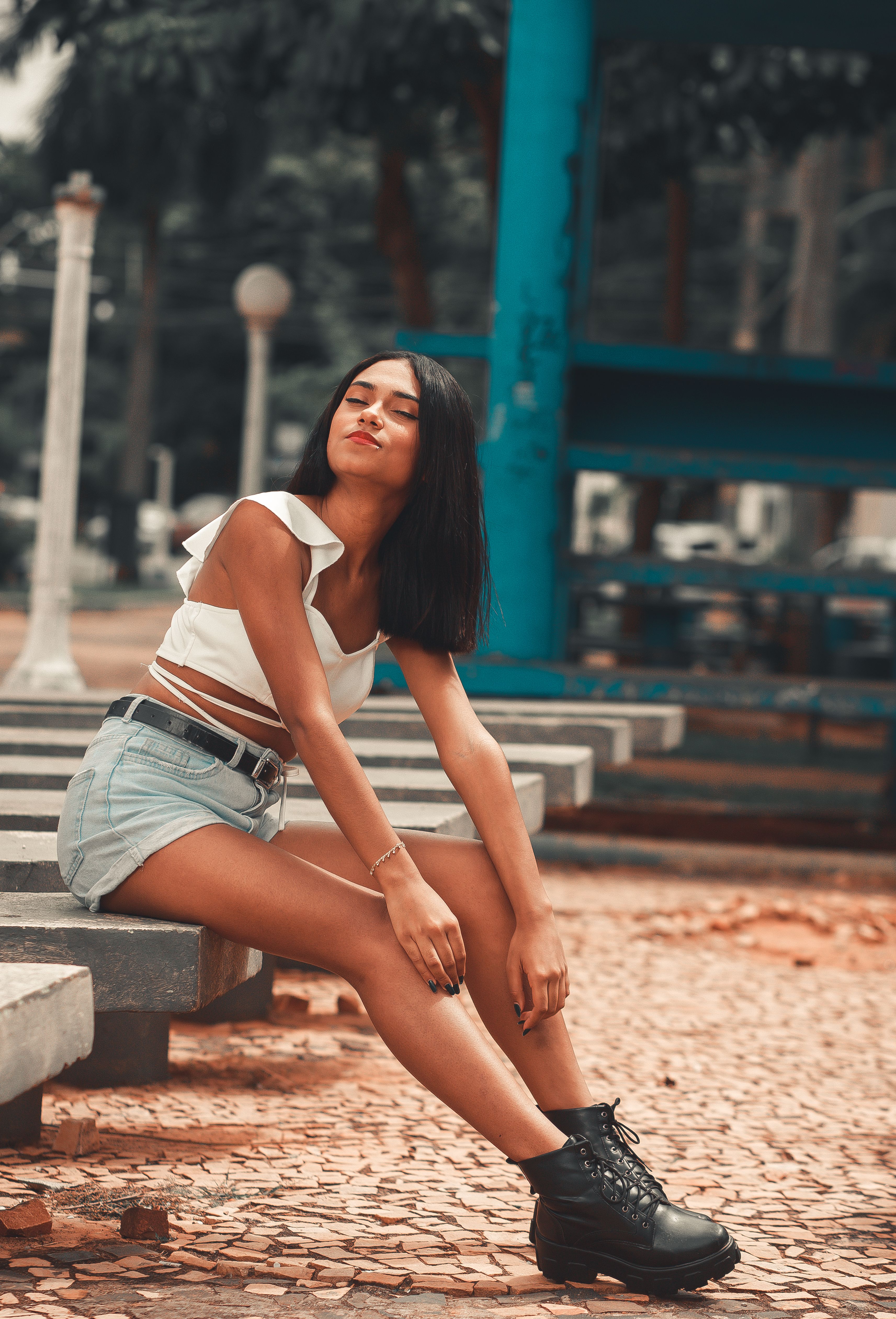 Brunette Woman Sitting and Posing with Eyes Closed · Free Stock Photo