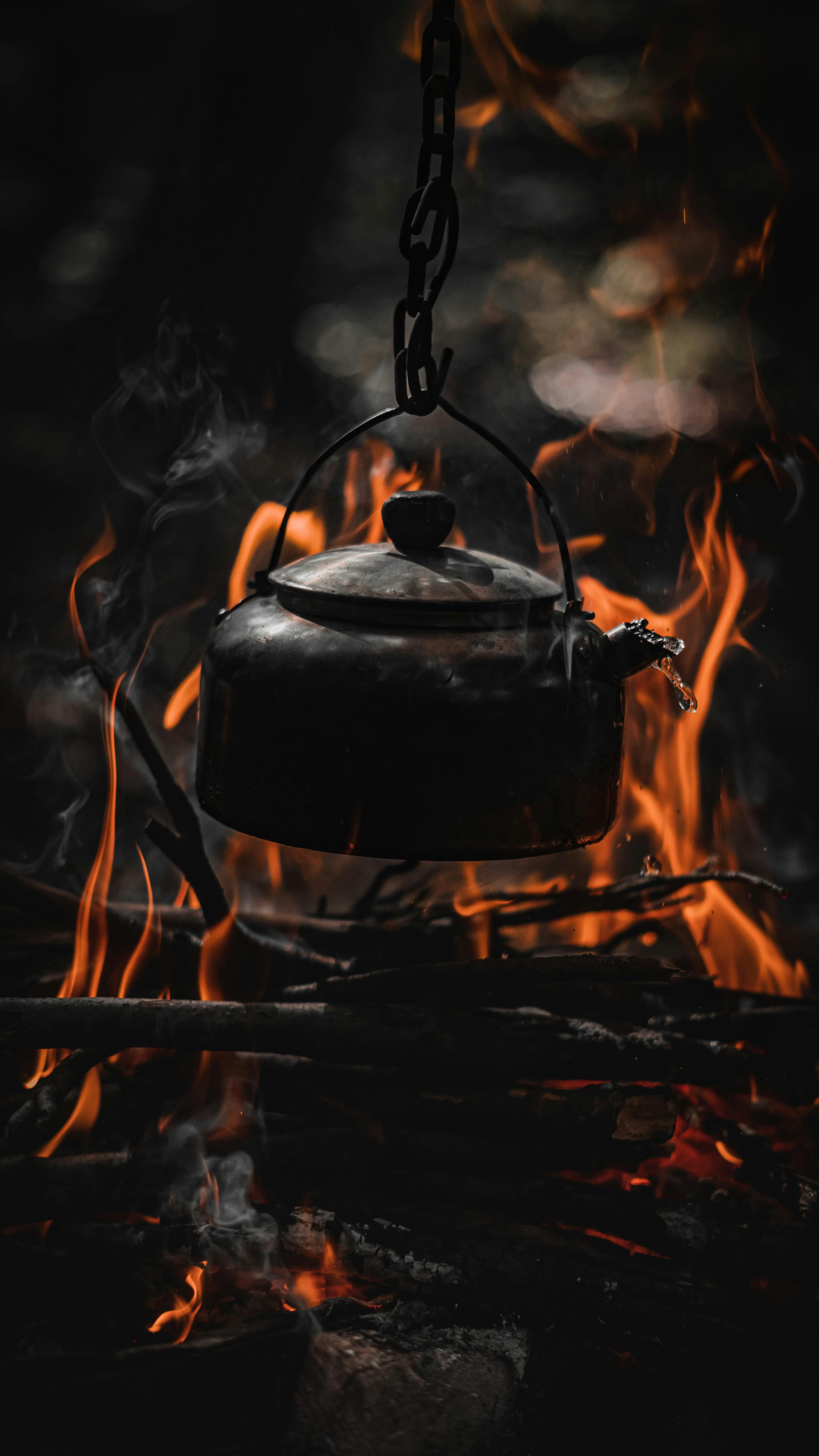 Hand in Glove Holding Kettle over Bonfire in Winter · Free Stock Photo