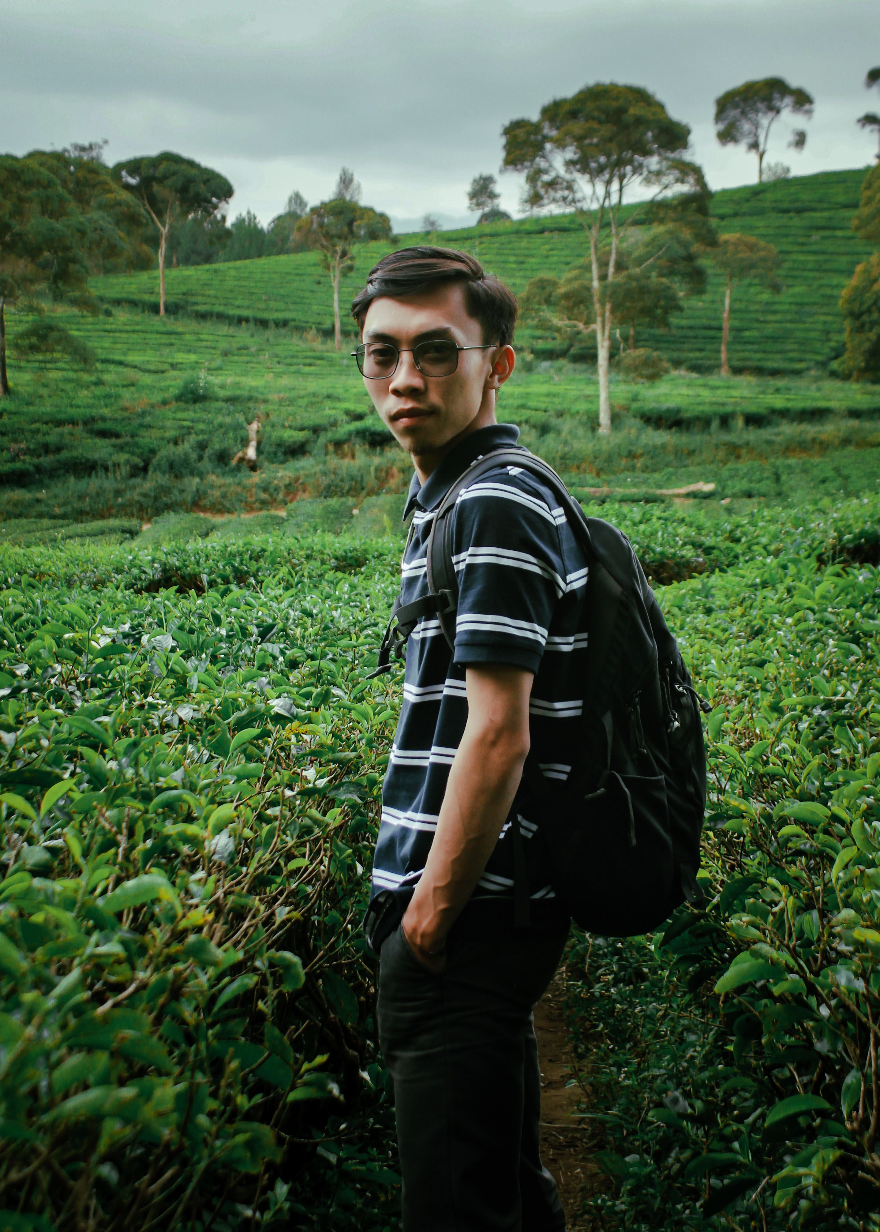 Man with Backpack in Field · Free Stock Photo