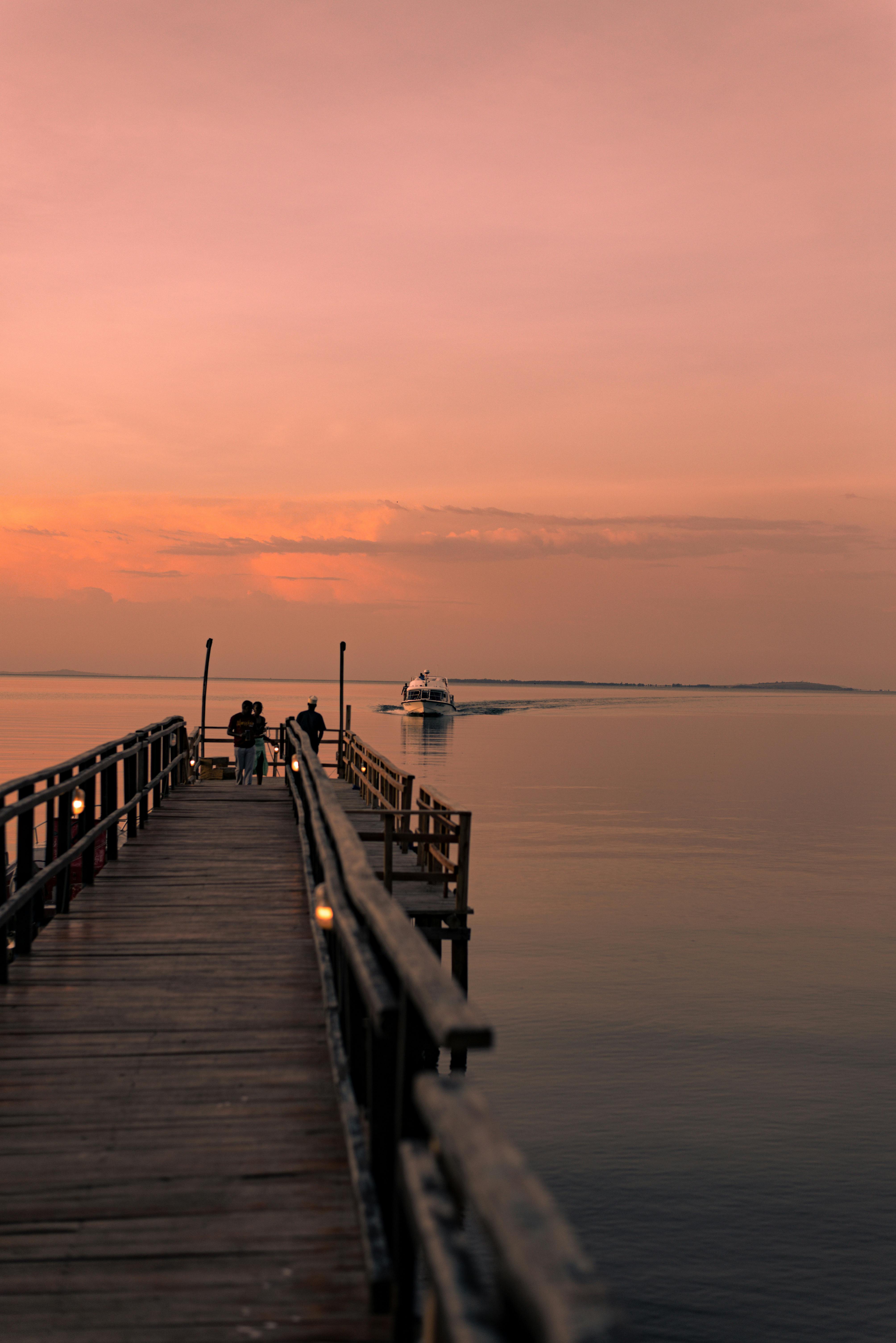 Boat Heading Towards a Pier at Sunset · Free Stock Photo