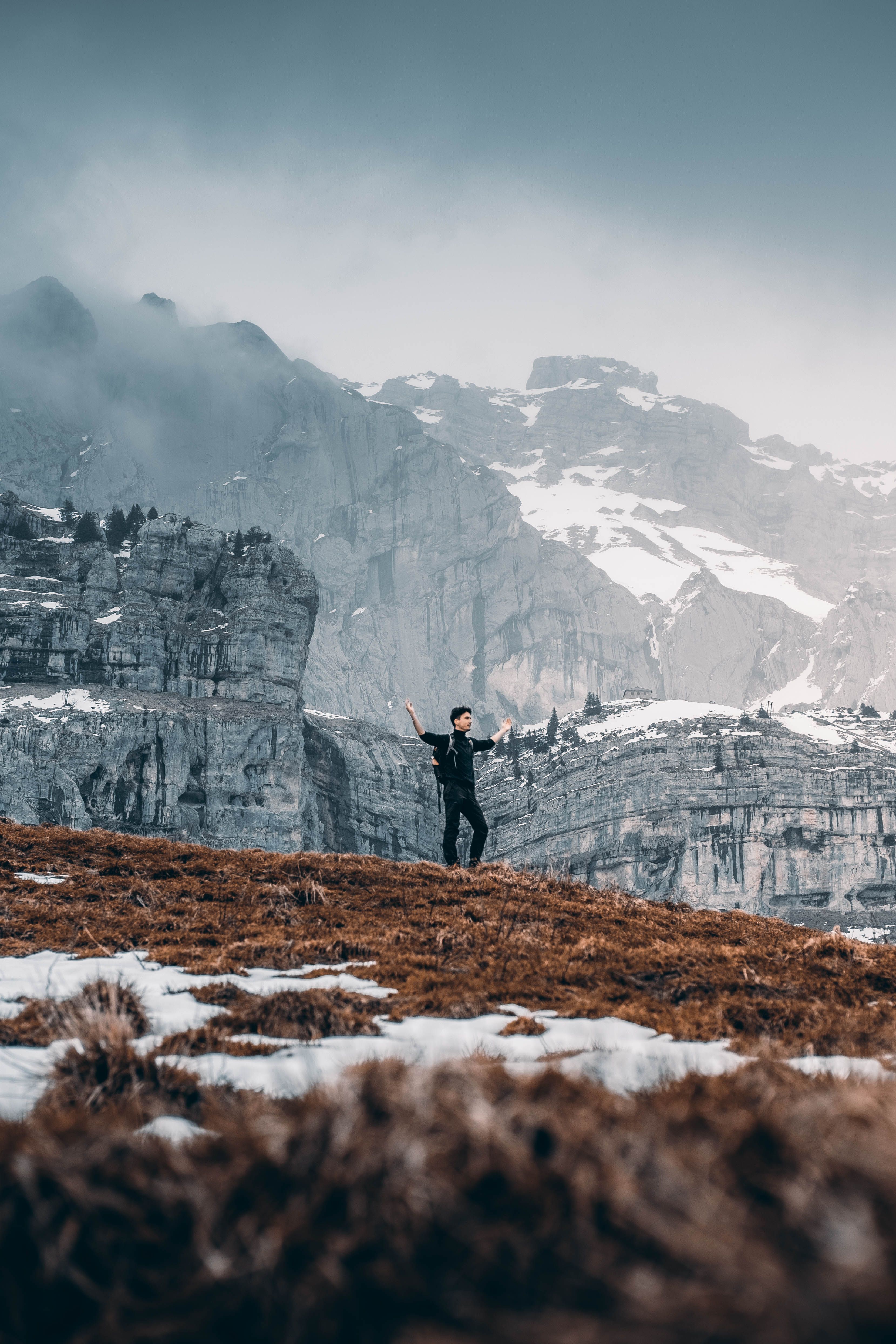 Hiker in Mountains Raising Hands · Free Stock Photo