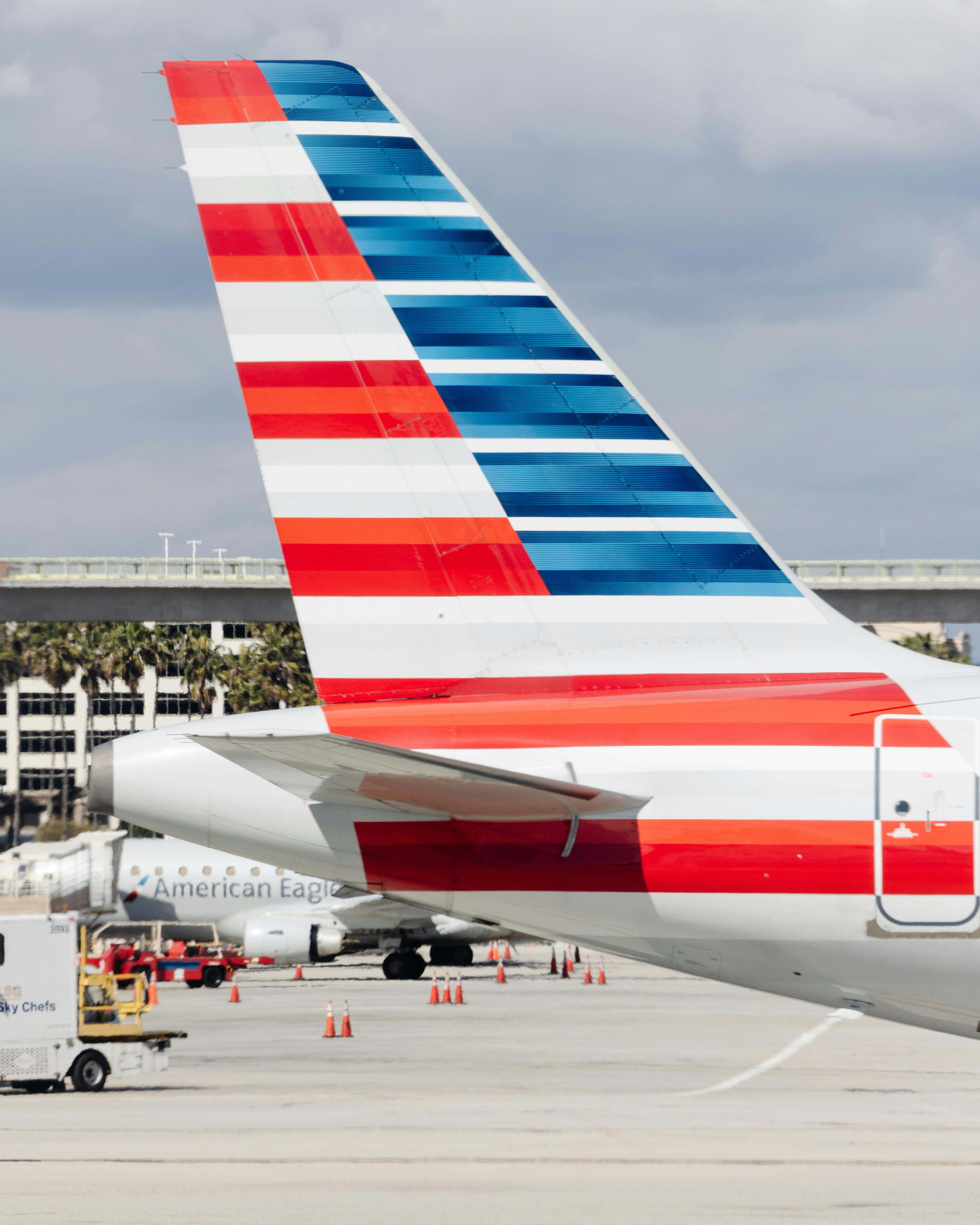 Low-angle Photography of Building Showing Airplane on Skies · Free ...