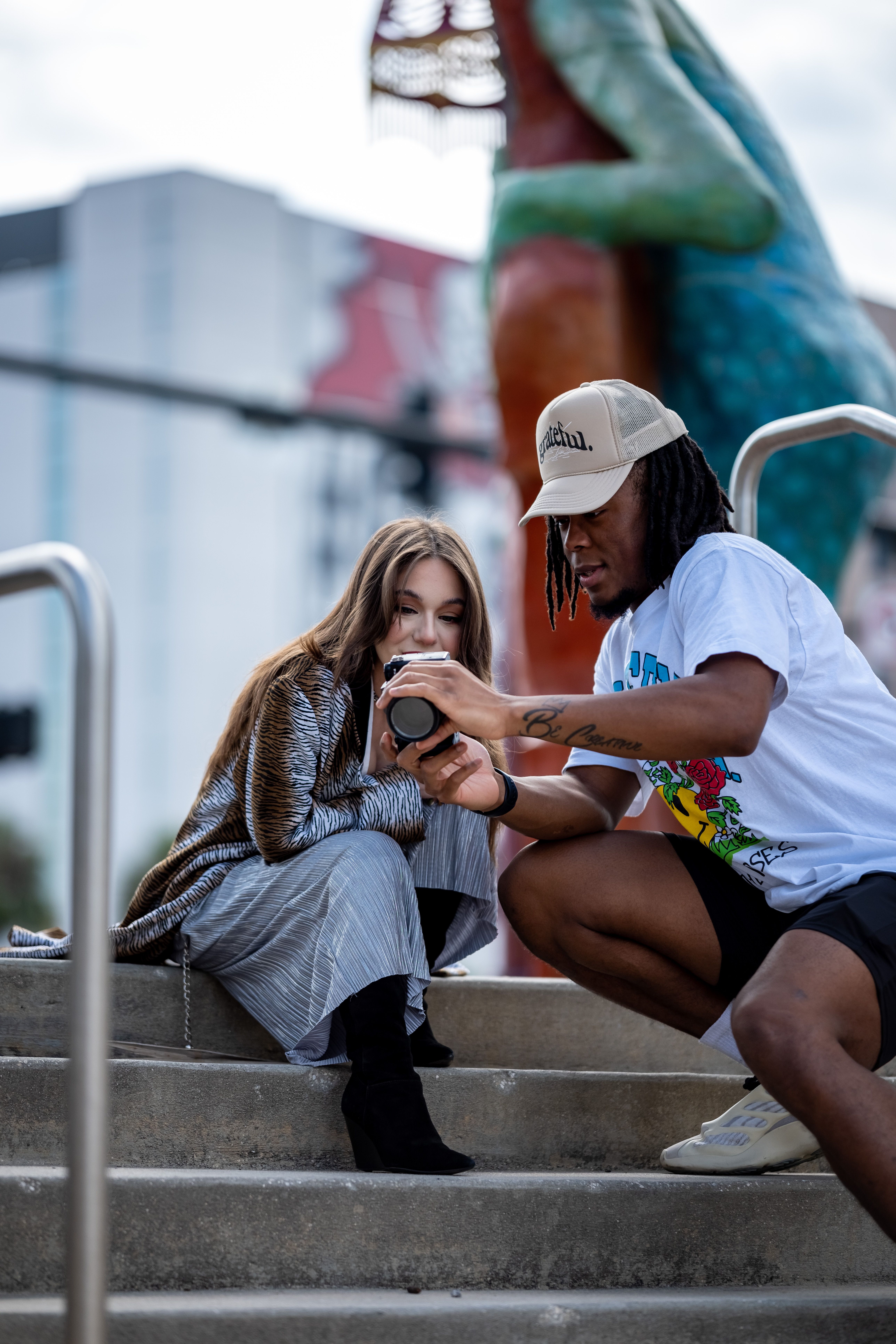 Man Showing Woman a Photo on a Camera · Free Stock Photo