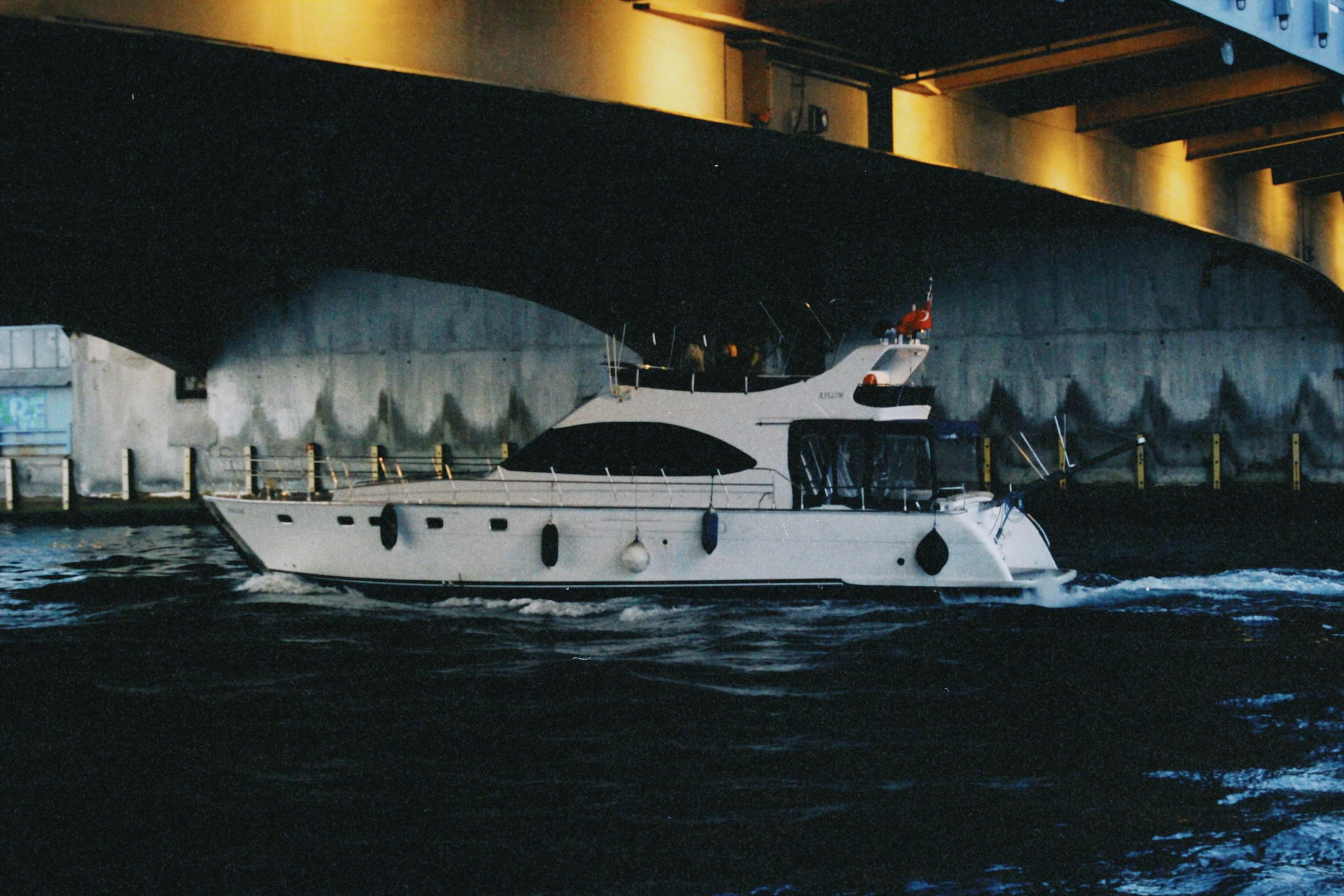 A Yacht Sailing under a Bridge · Free Stock Photo