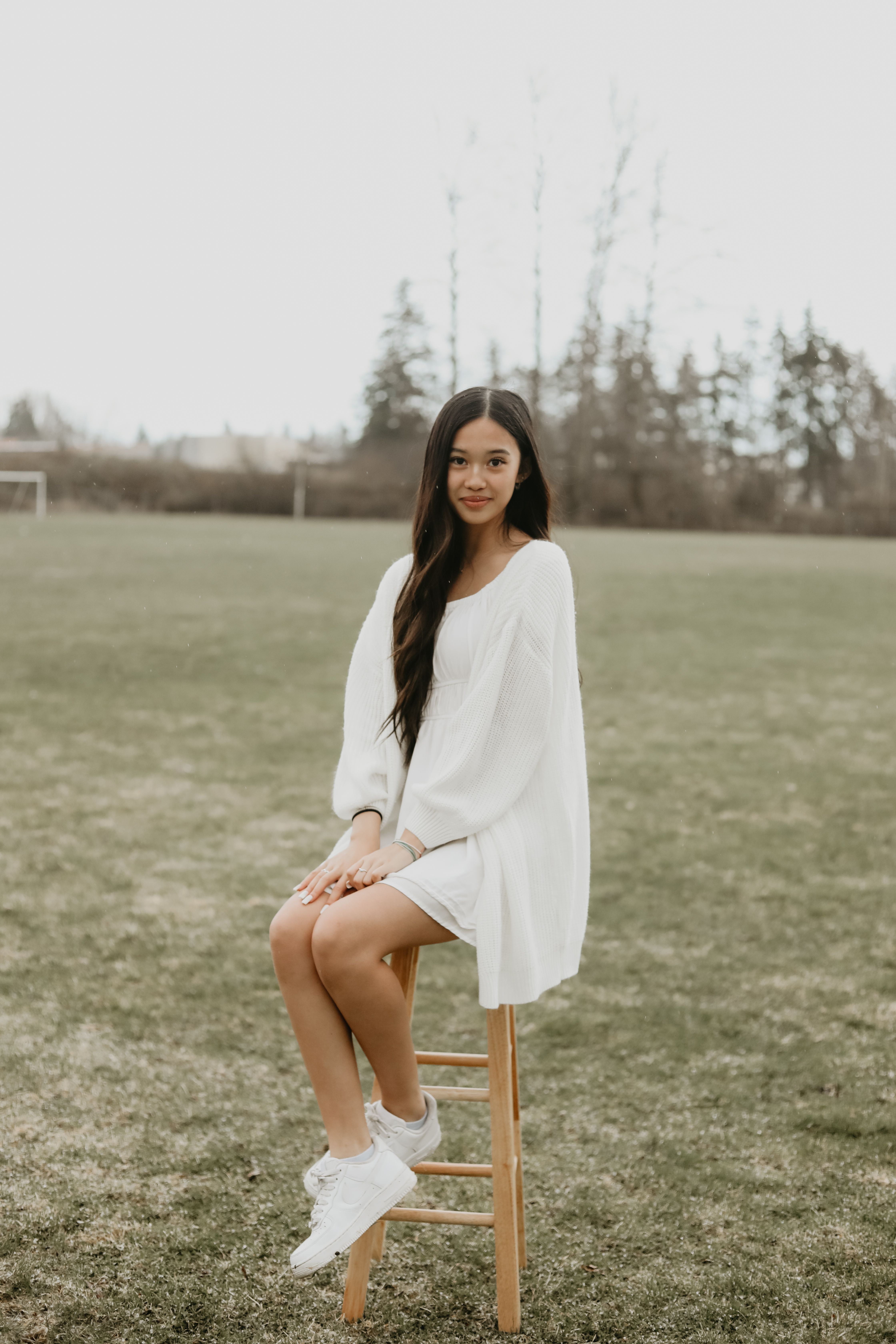 Woman Standing Next to Woman Sitting on Stool · Free Stock Photo