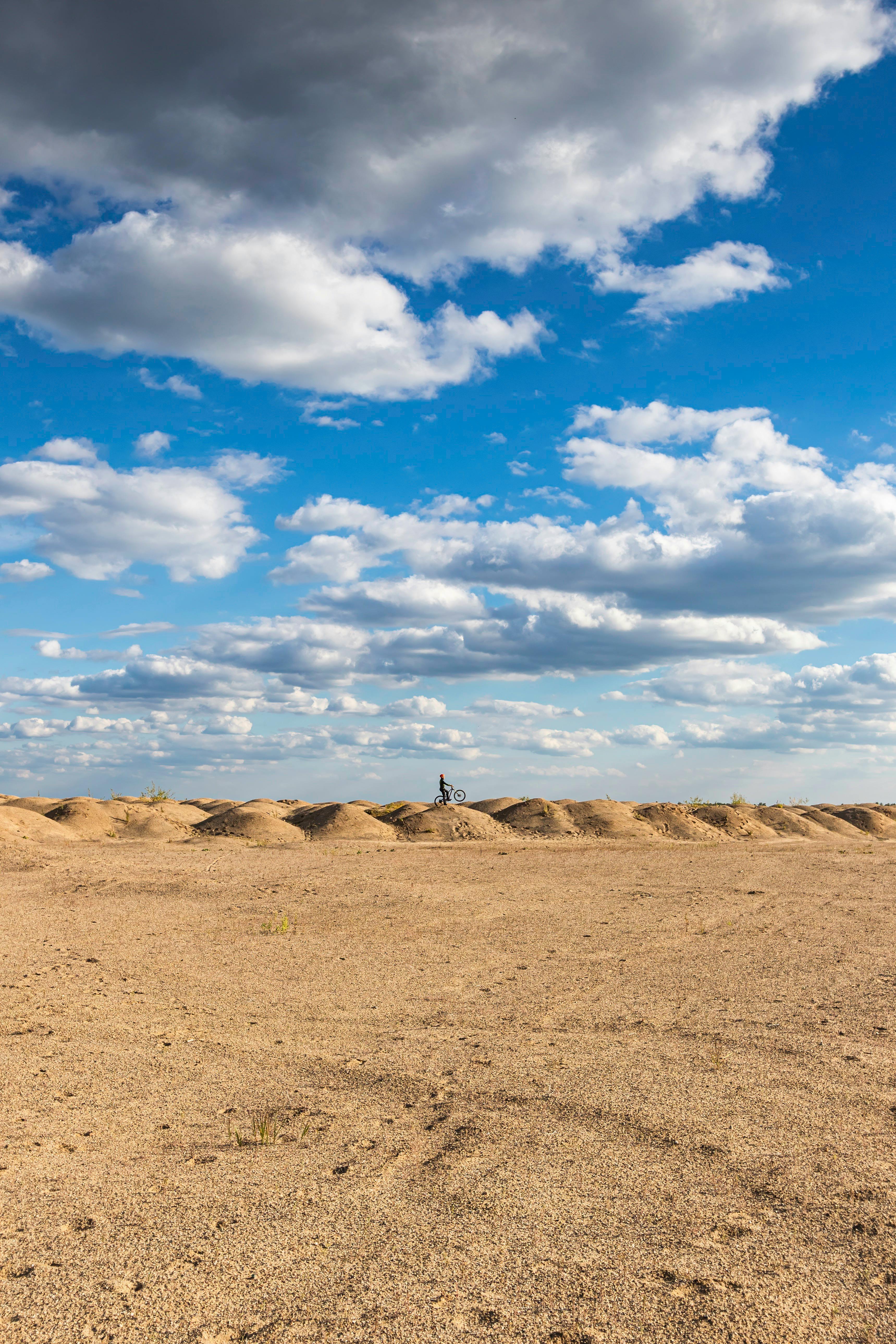 Fluffy Clouds over Desert · Free Stock Photo
