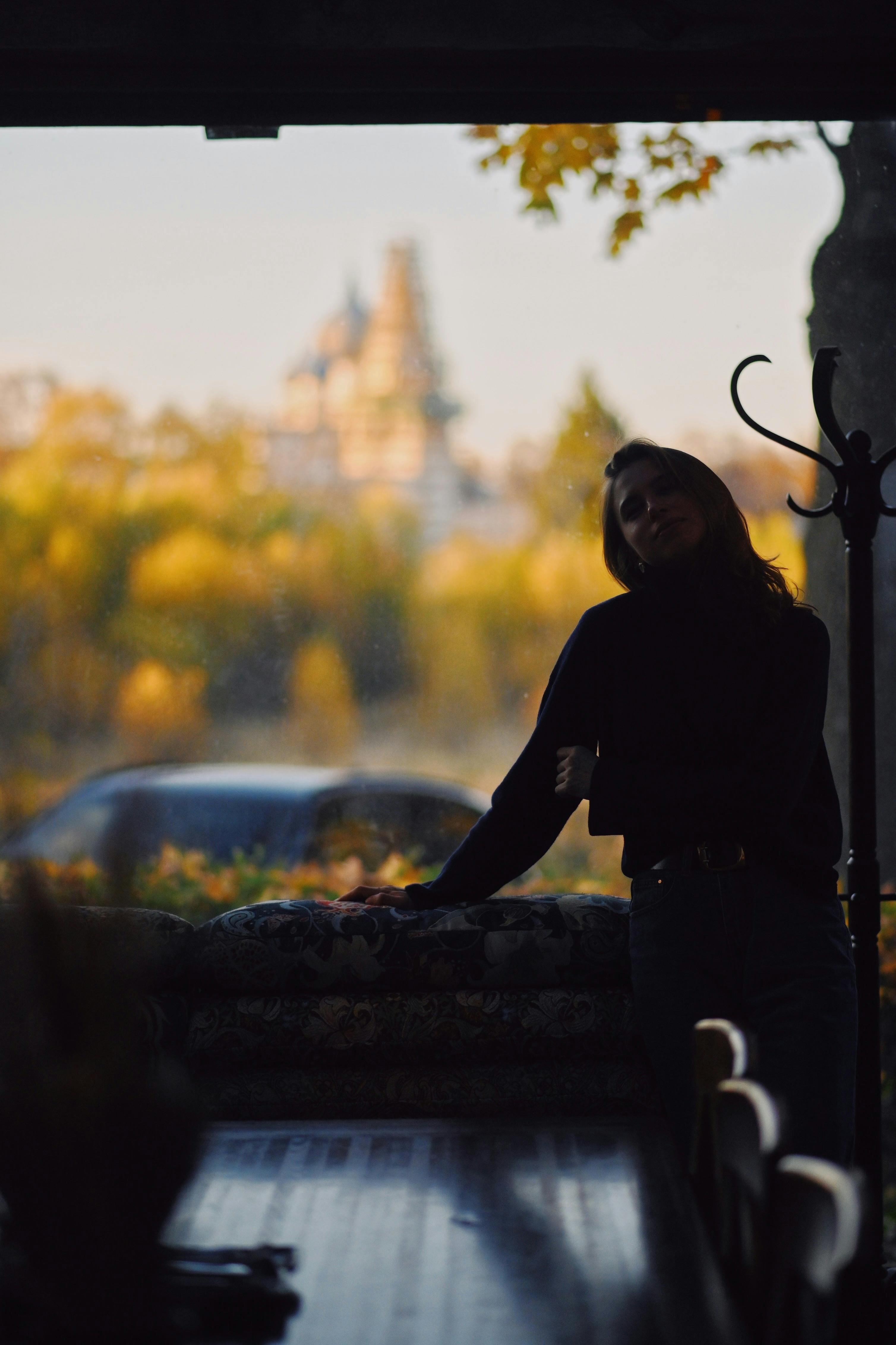 Woman Standing in Window · Free Stock Photo