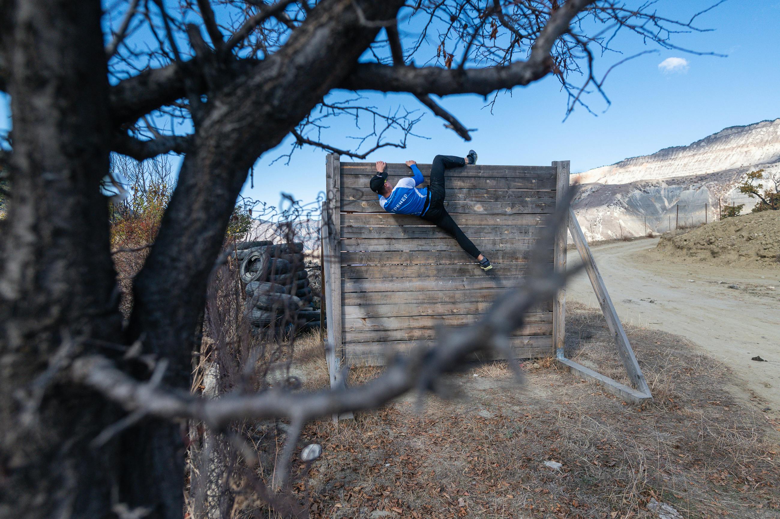 Man Climbing on Obstacle Course Wall · Free Stock Photo