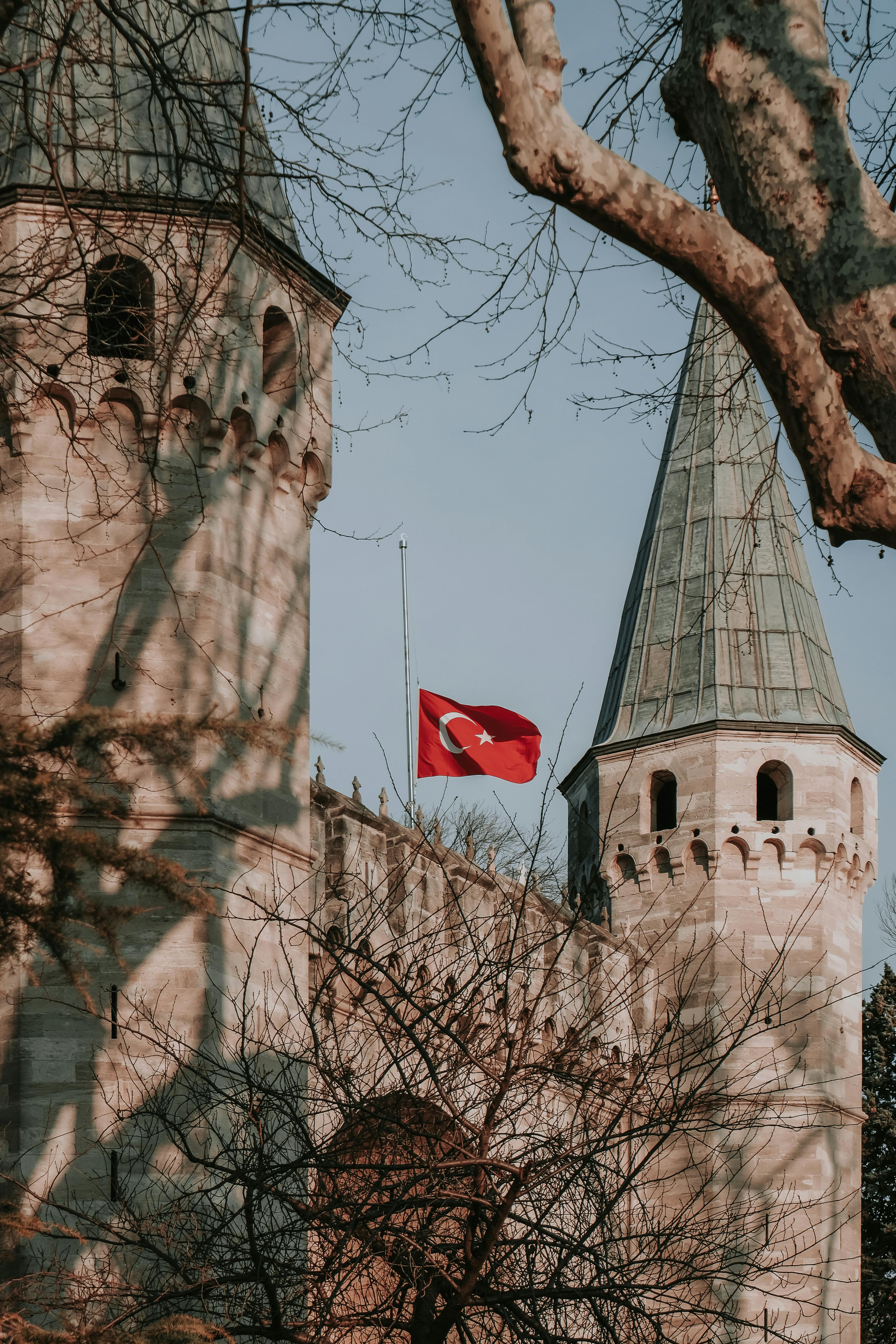 A red flag flies over a castle · Free Stock Photo