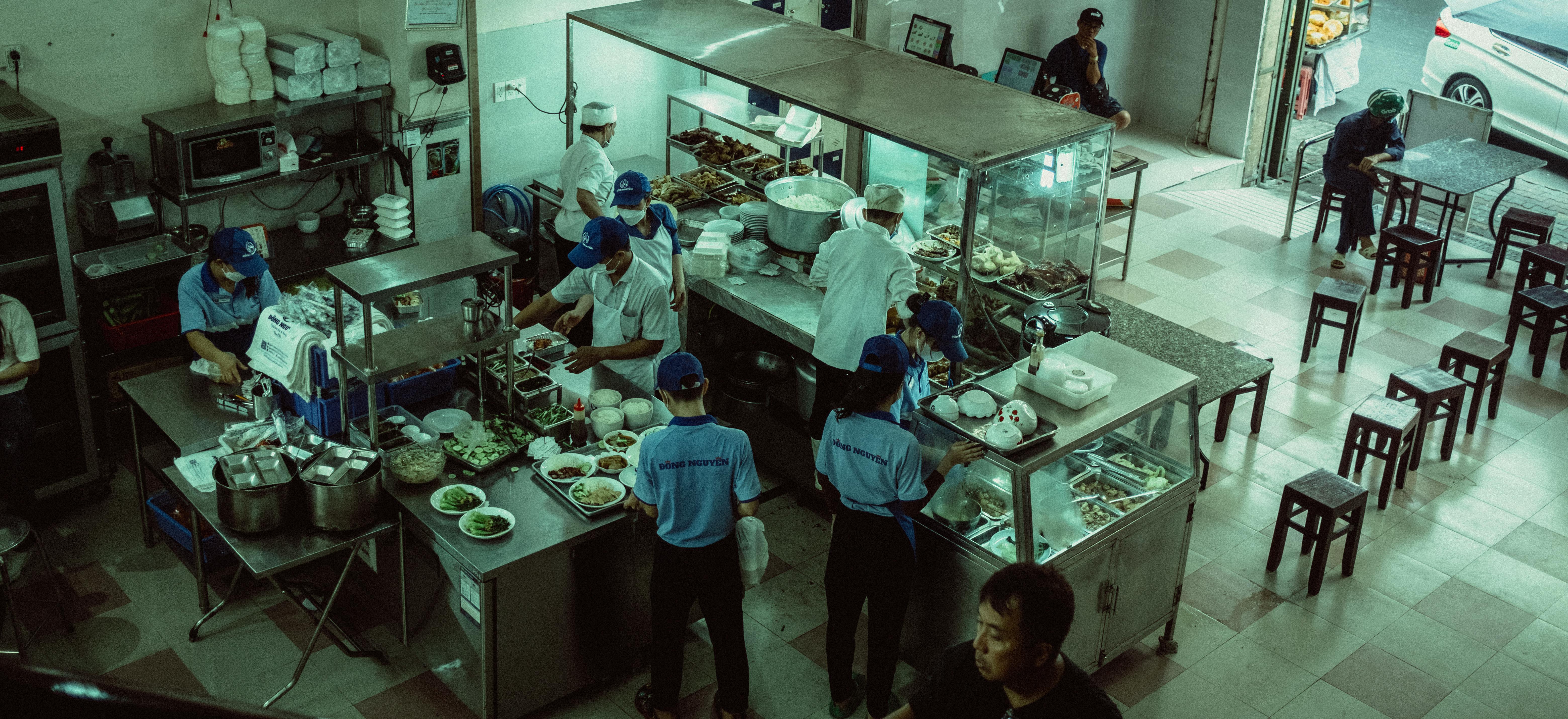 High Angle Shot of Chefs Preparing Meals in a Canteen · Free Stock Photo