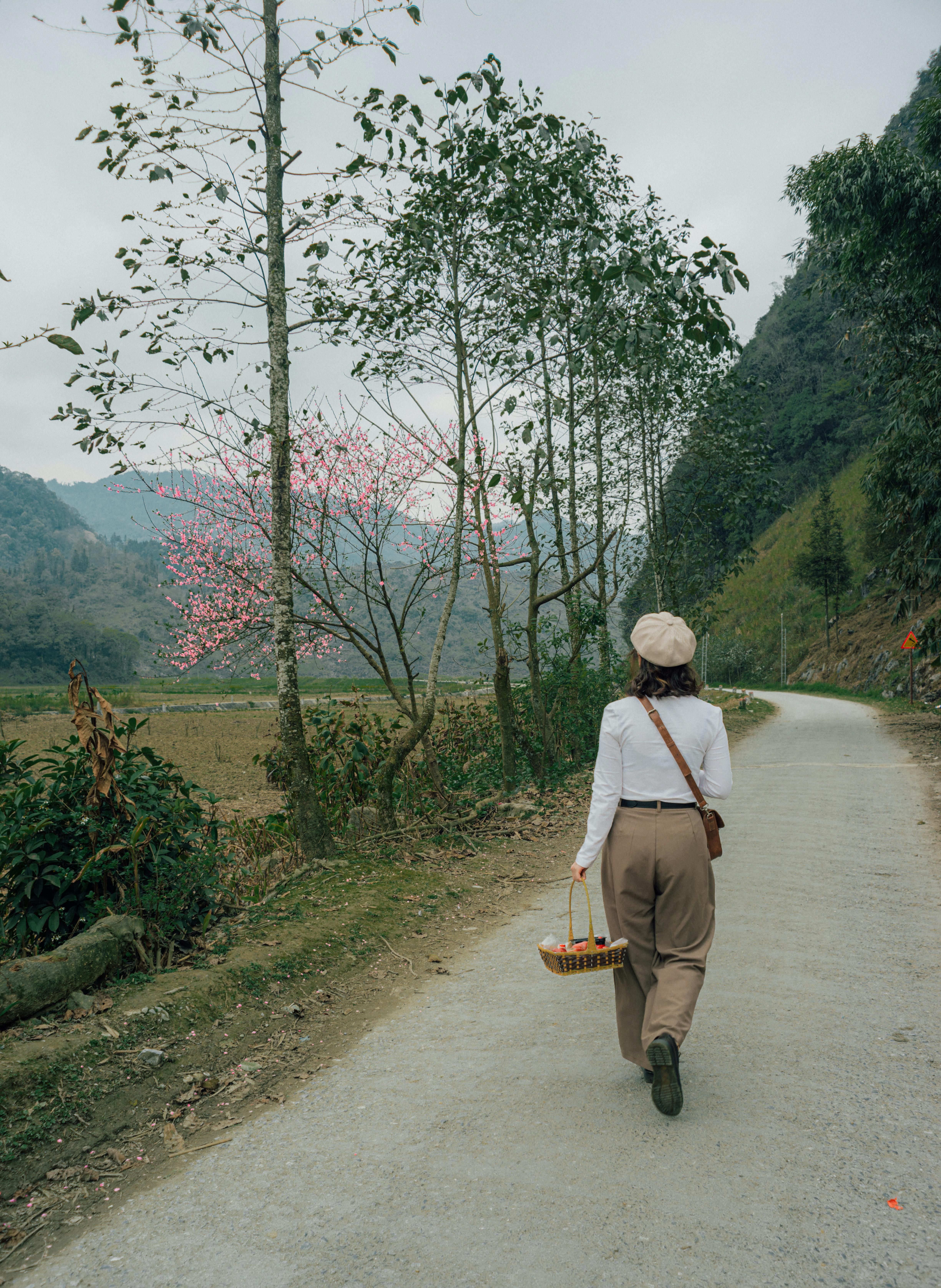 Woman Walking on Rural Road · Free Stock Photo