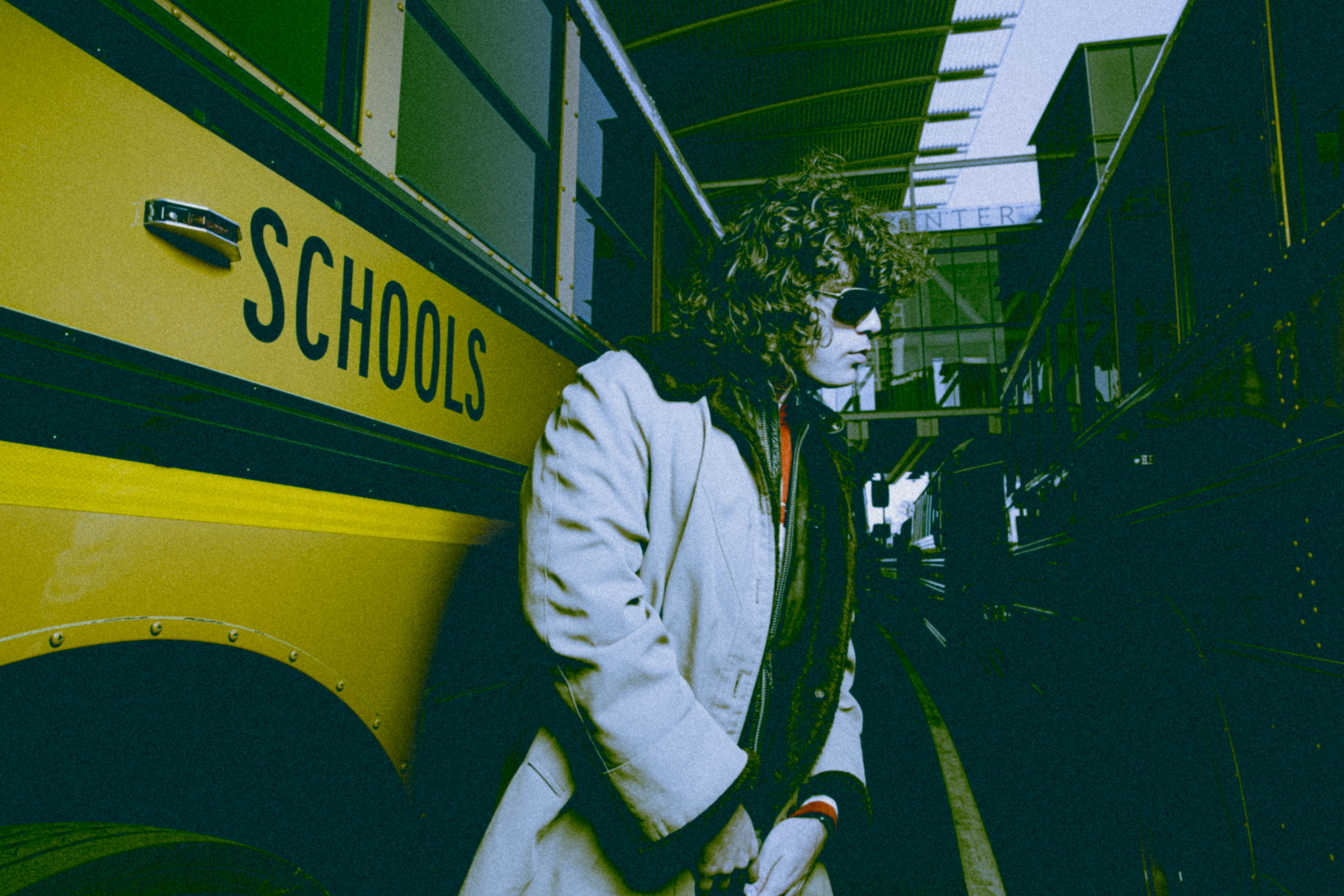 Man with Full Makeup Standing next to School Bus · Free Stock Photo