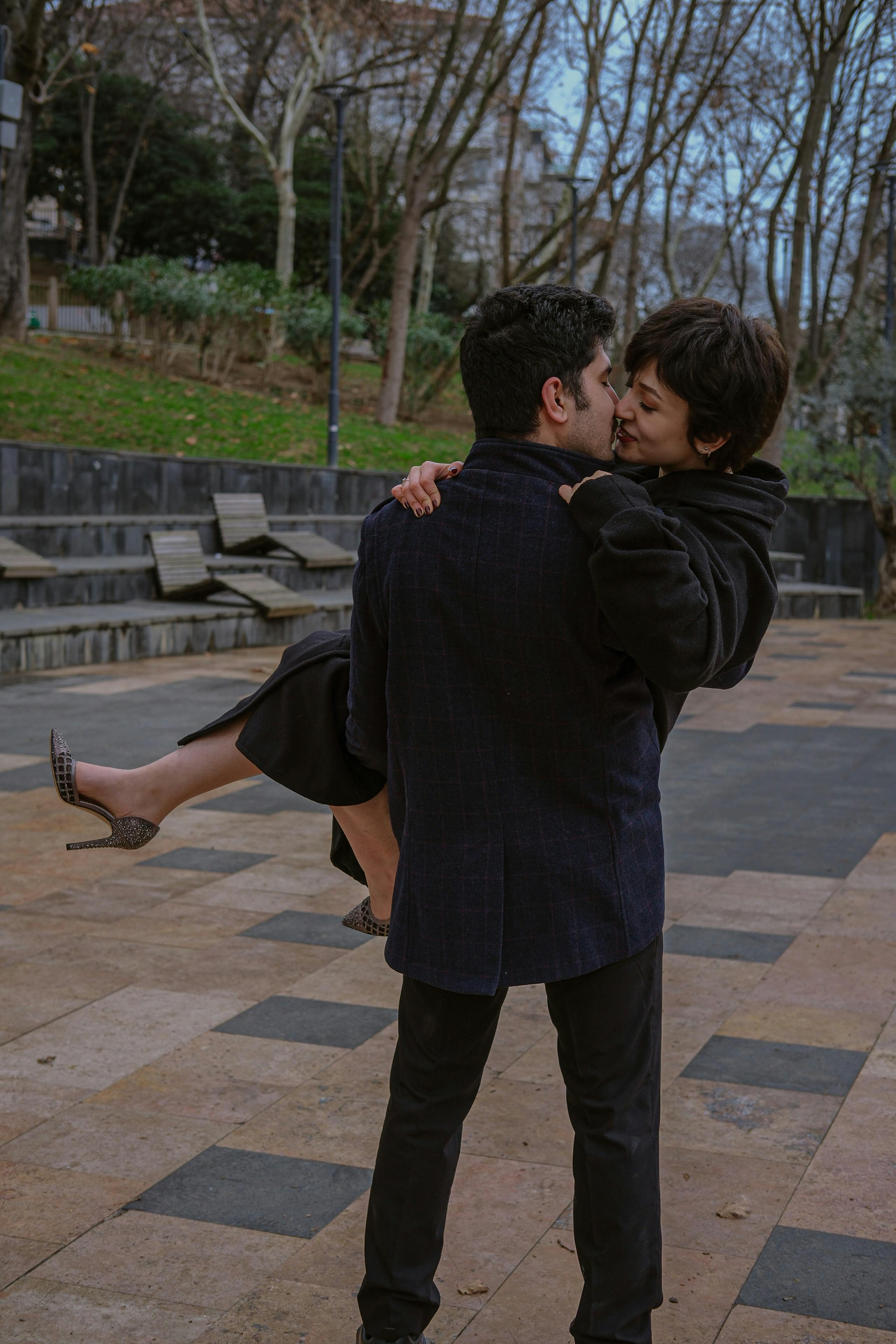 A man is carrying a woman in his arms · Free Stock Photo