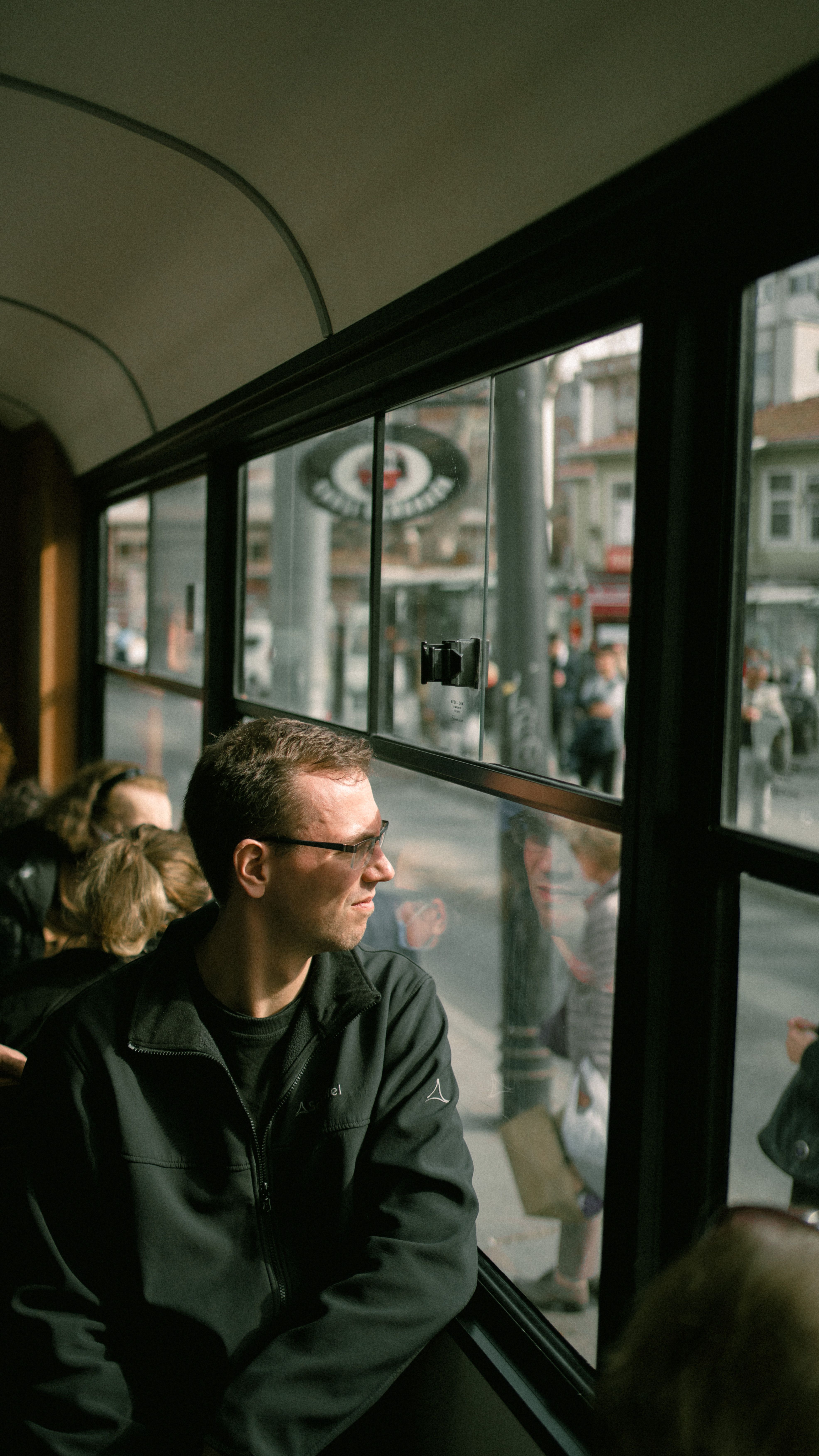 Man Looking through Windows on Public Transportation · Free Stock Photo