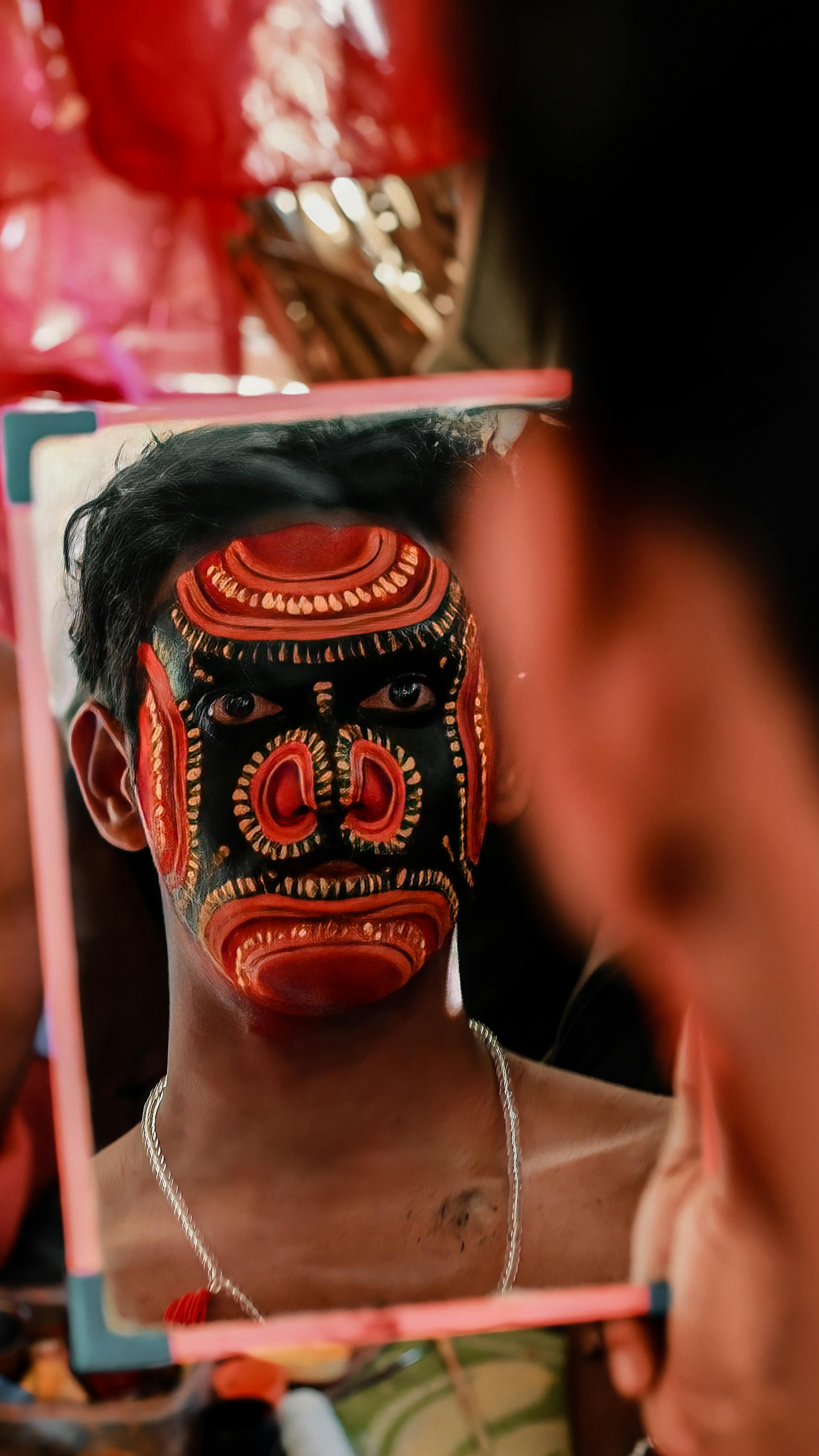 Mirror Reflection of a Man with His Face Painted for a Traditional ...