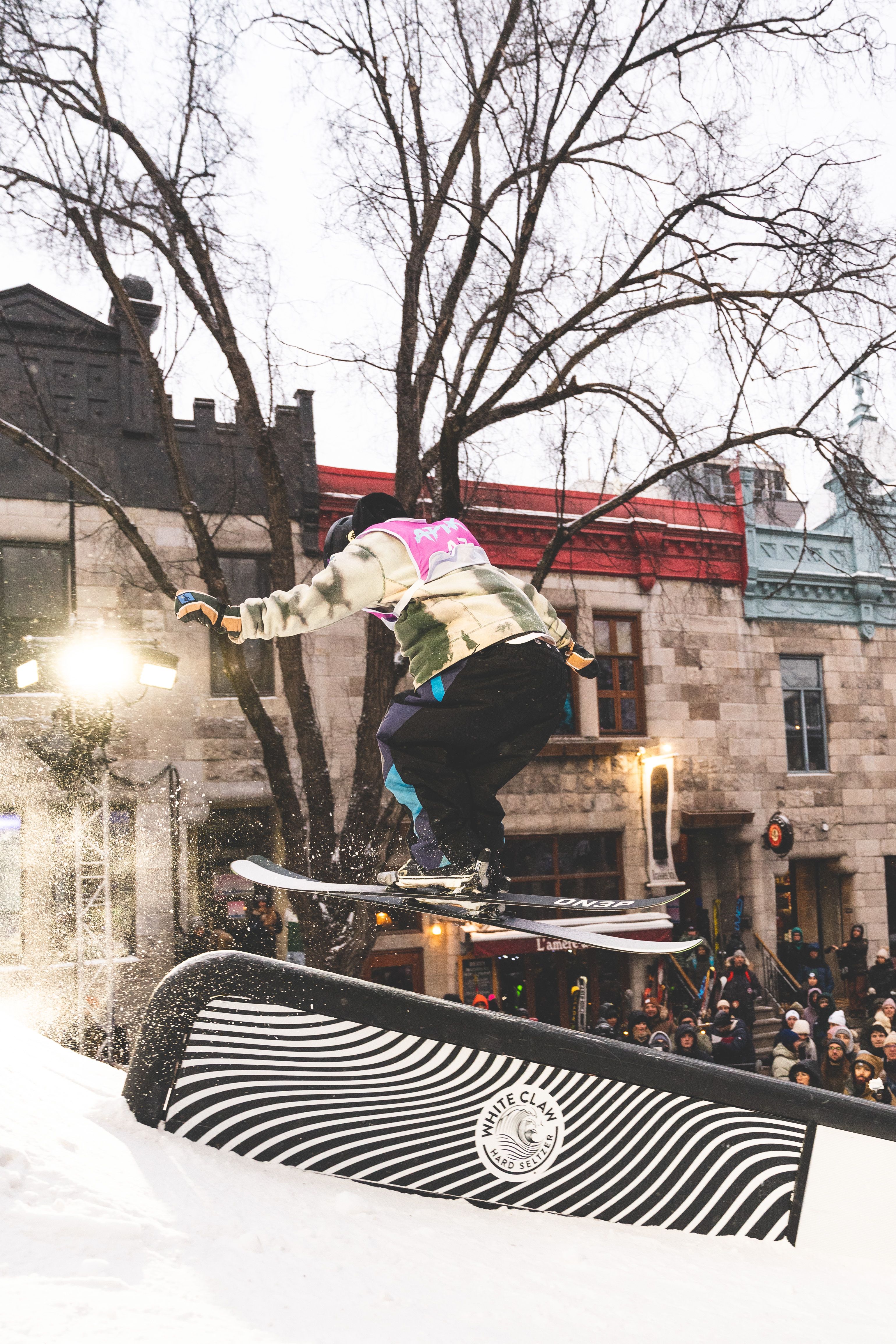 A snowboarder is performing a trick on a ramp · Free Stock Photo