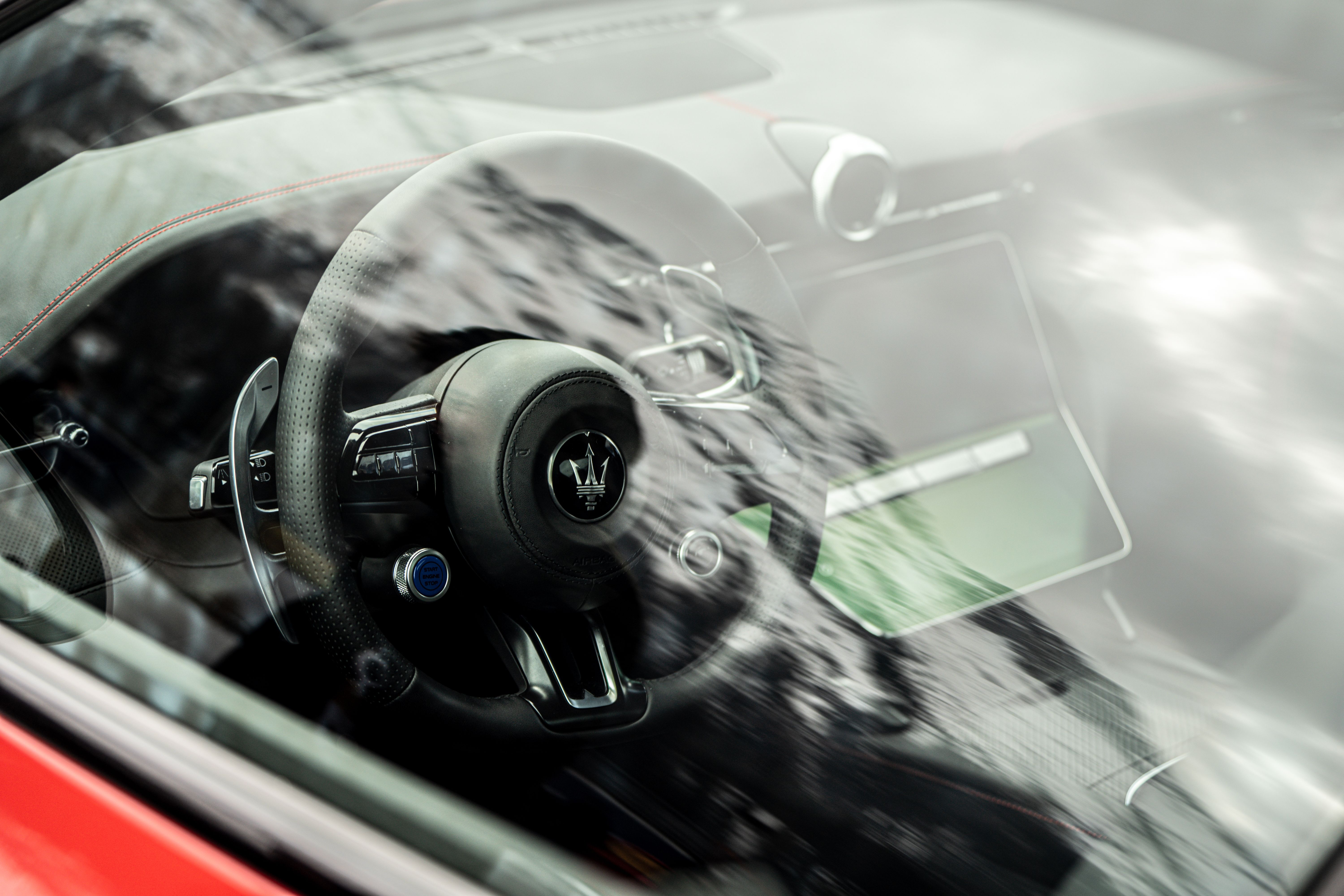 A Steering Wheel Behind a Car Window · Free Stock Photo