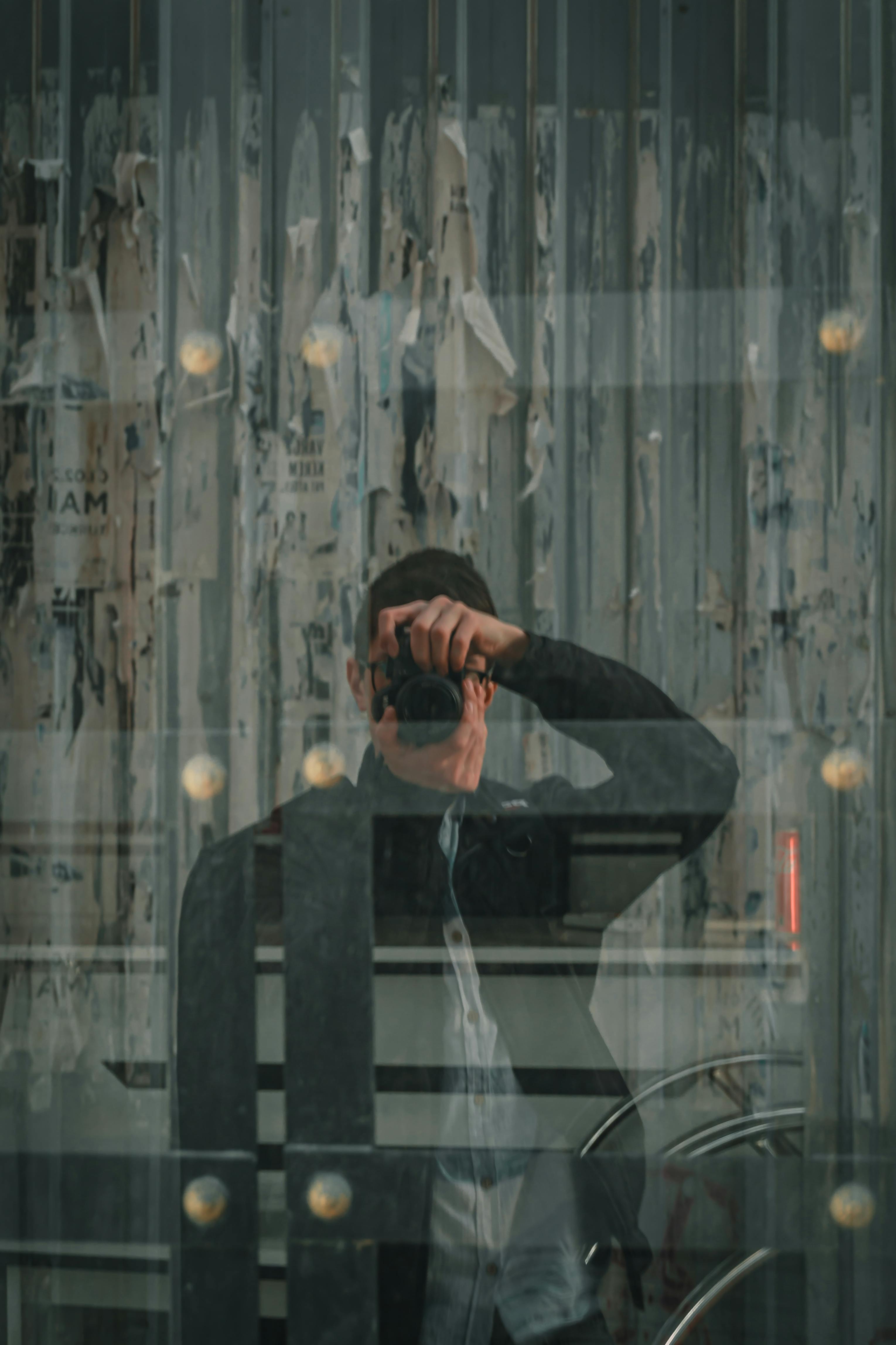 Person Taking Selfie in Reflection on Window · Free Stock Photo
