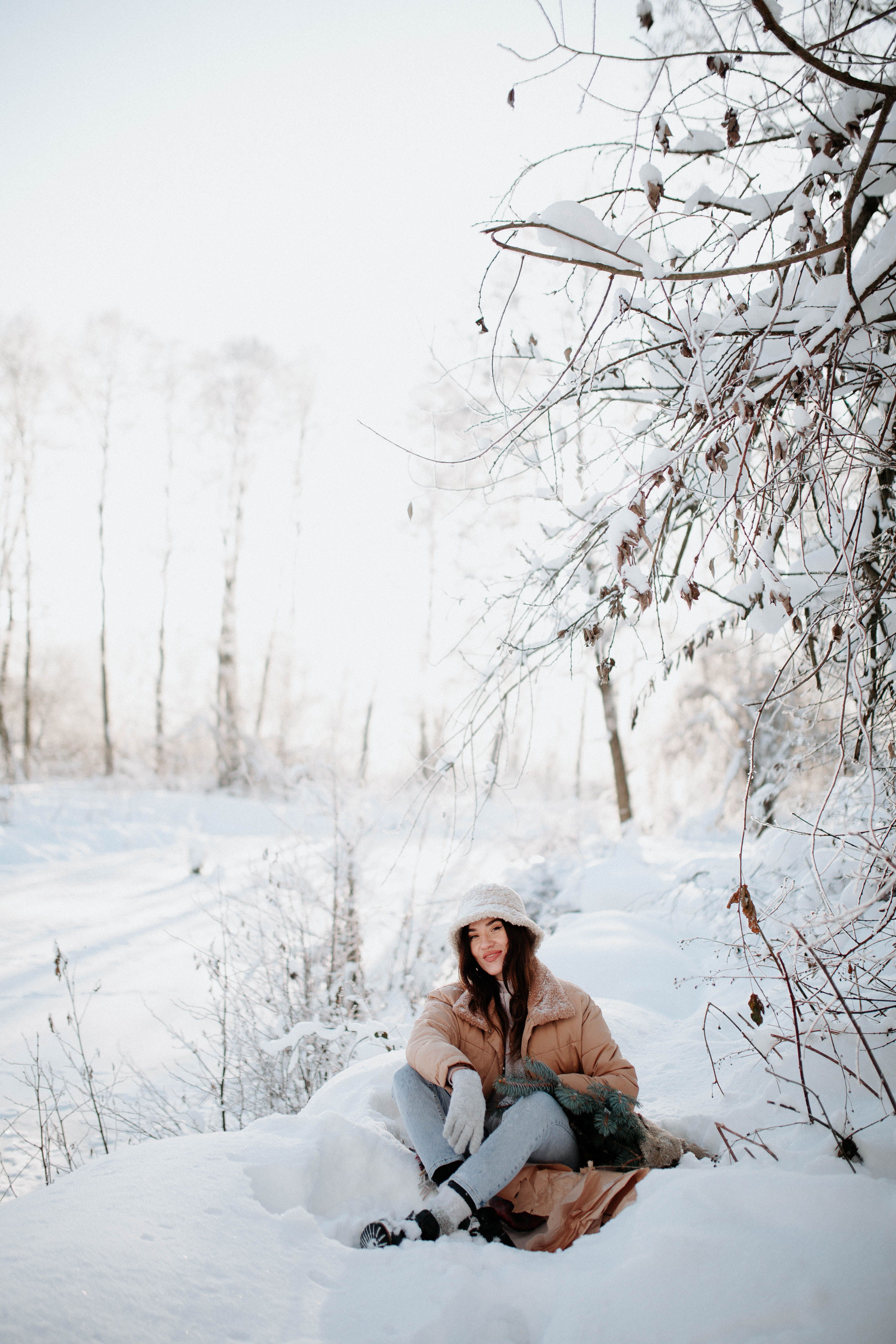 Smiling Woman Sitting on Snow · Free Stock Photo