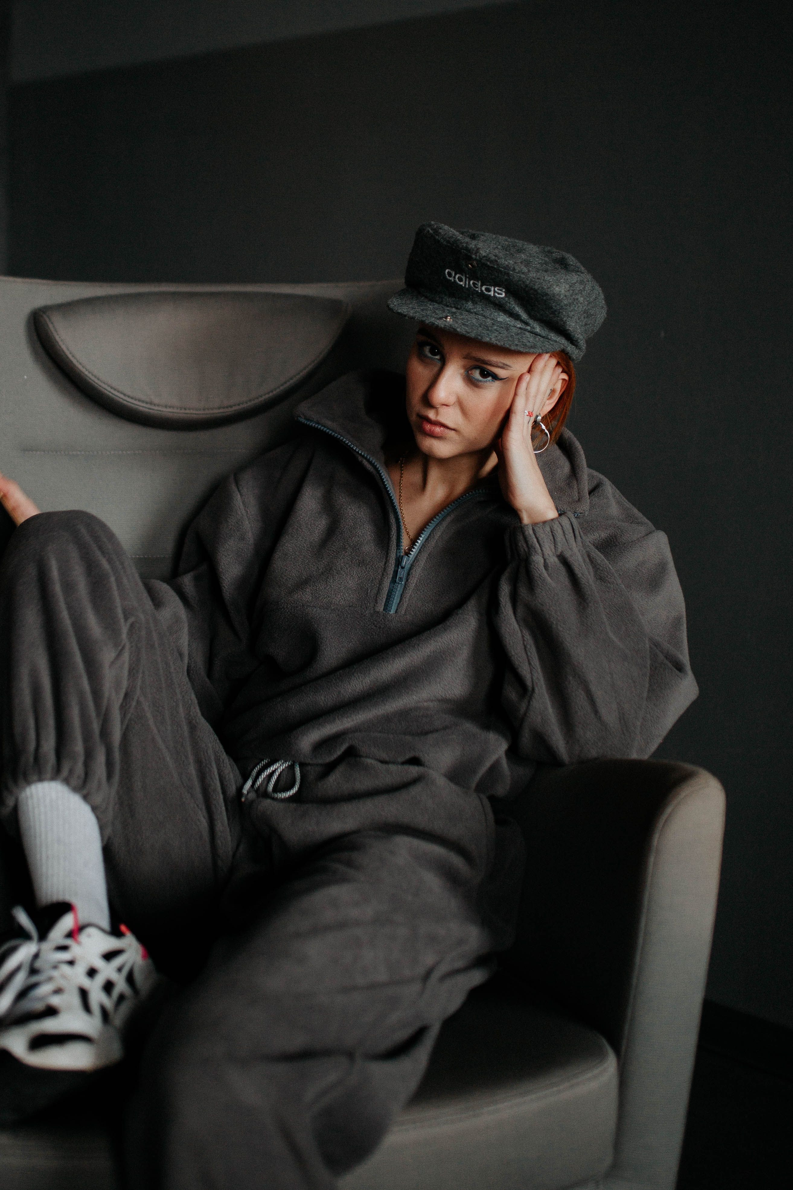 Redhead Woman Wearing a Khaki Fleece Tracksuit Sitting on an Armchair ...