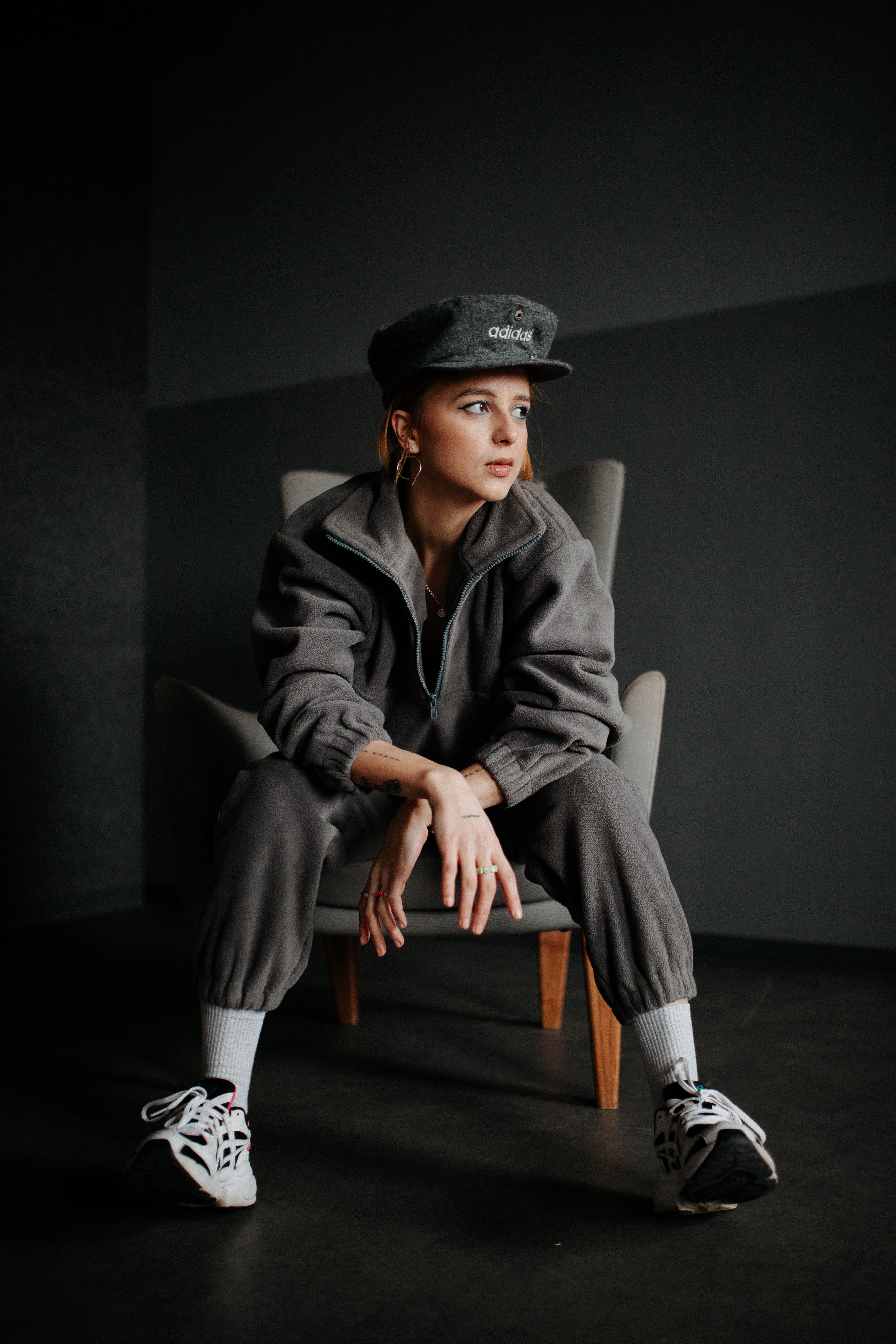 Redhead Woman Wearing a Khaki Fleece Tracksuit Sitting on an Armchair ...