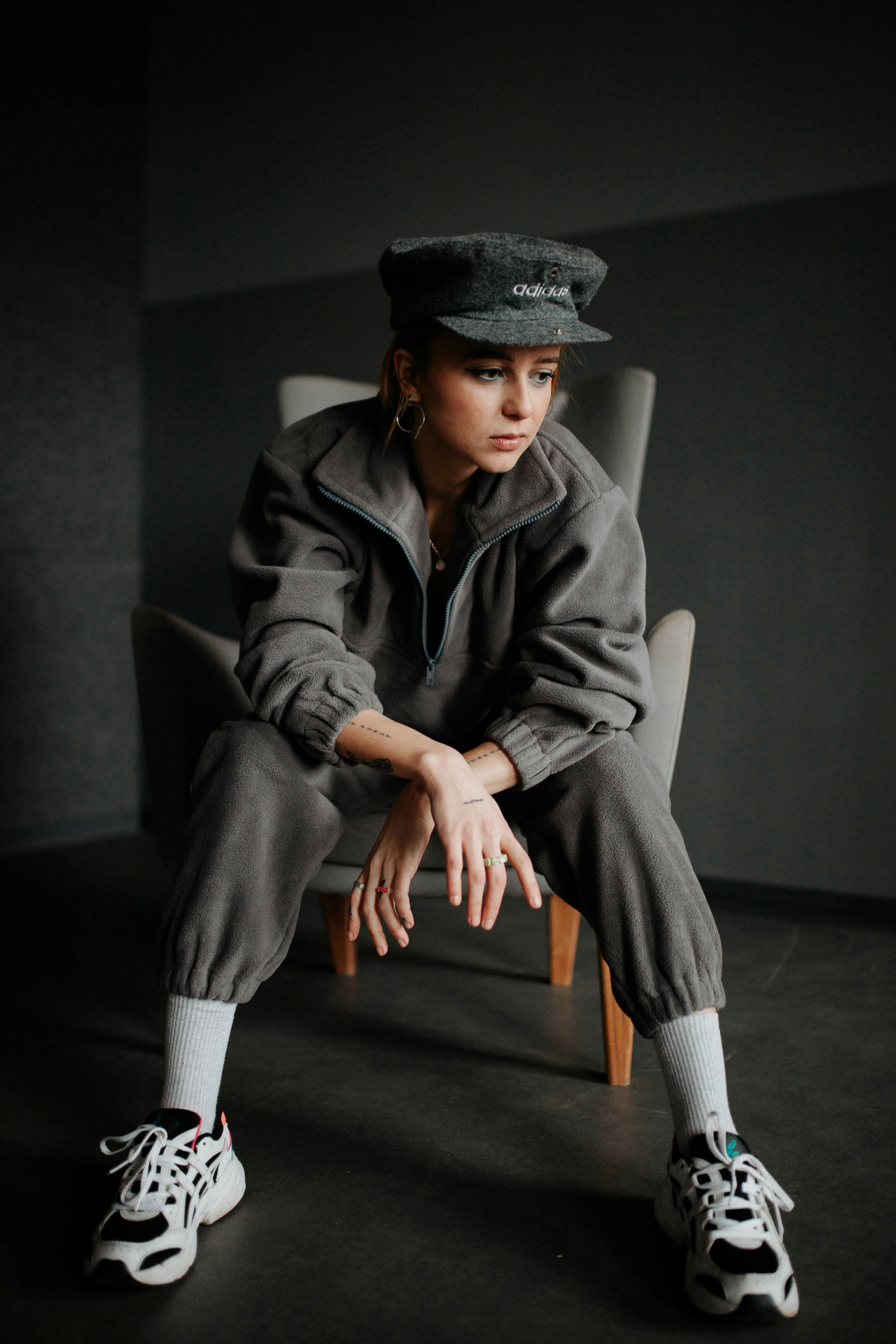 Redhead Woman Wearing a Khaki Fleece Tracksuit Sitting on an Armchair ...