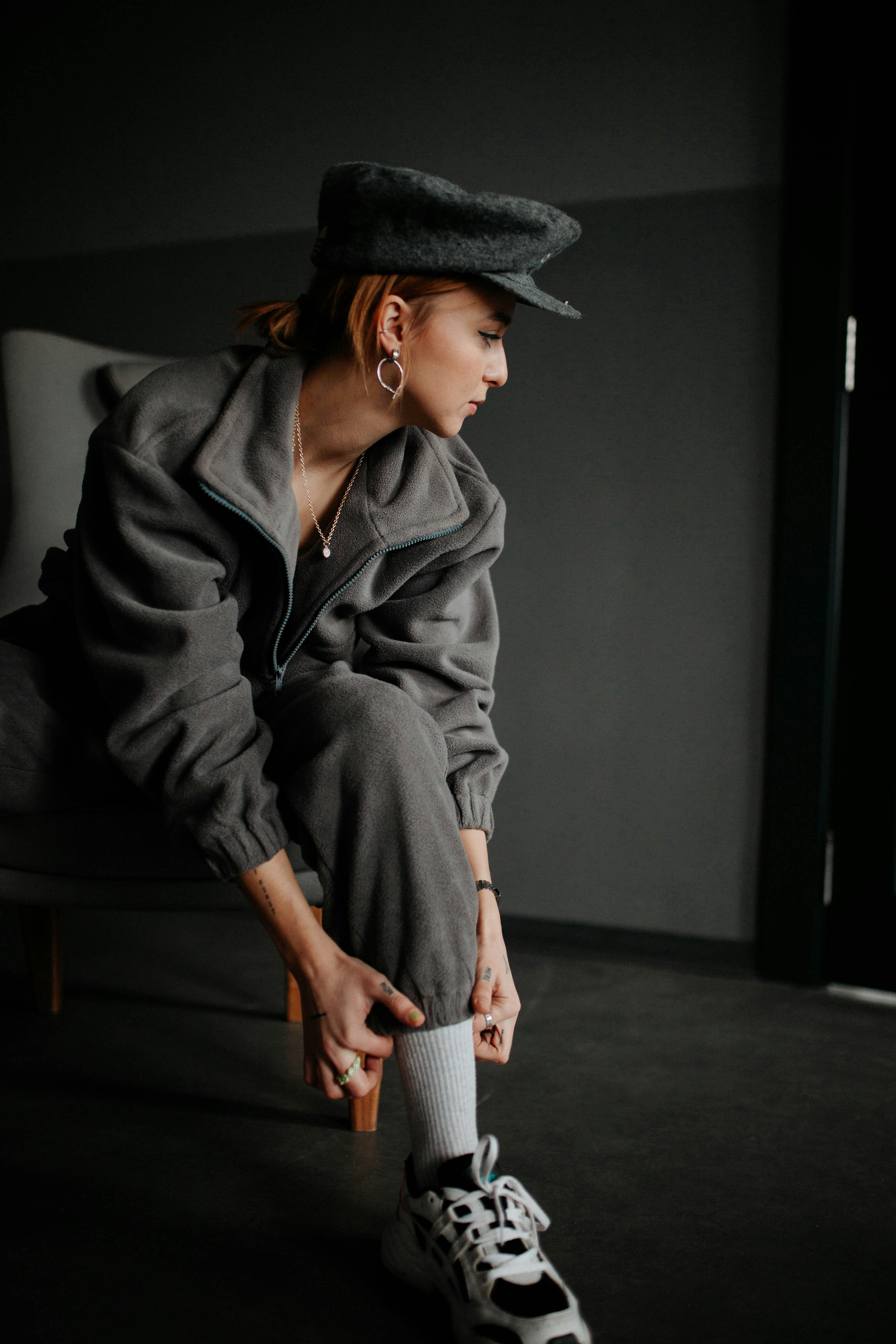 Redhead Woman Wearing a Khaki Fleece Tracksuit Sitting on an Armchair ...