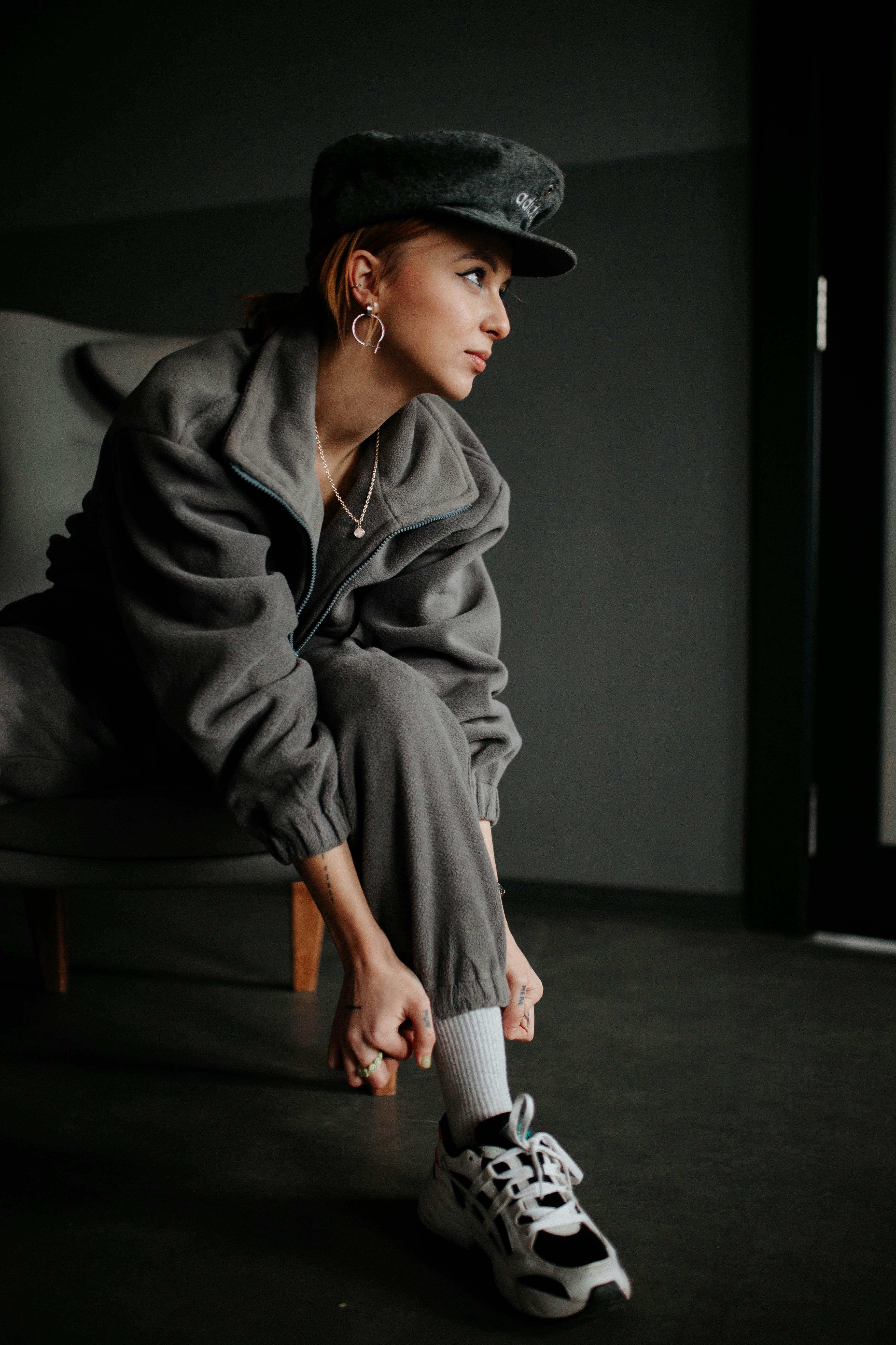 Woman in Charcoal Sweatshirt Sitting on Chair · Free Stock Photo