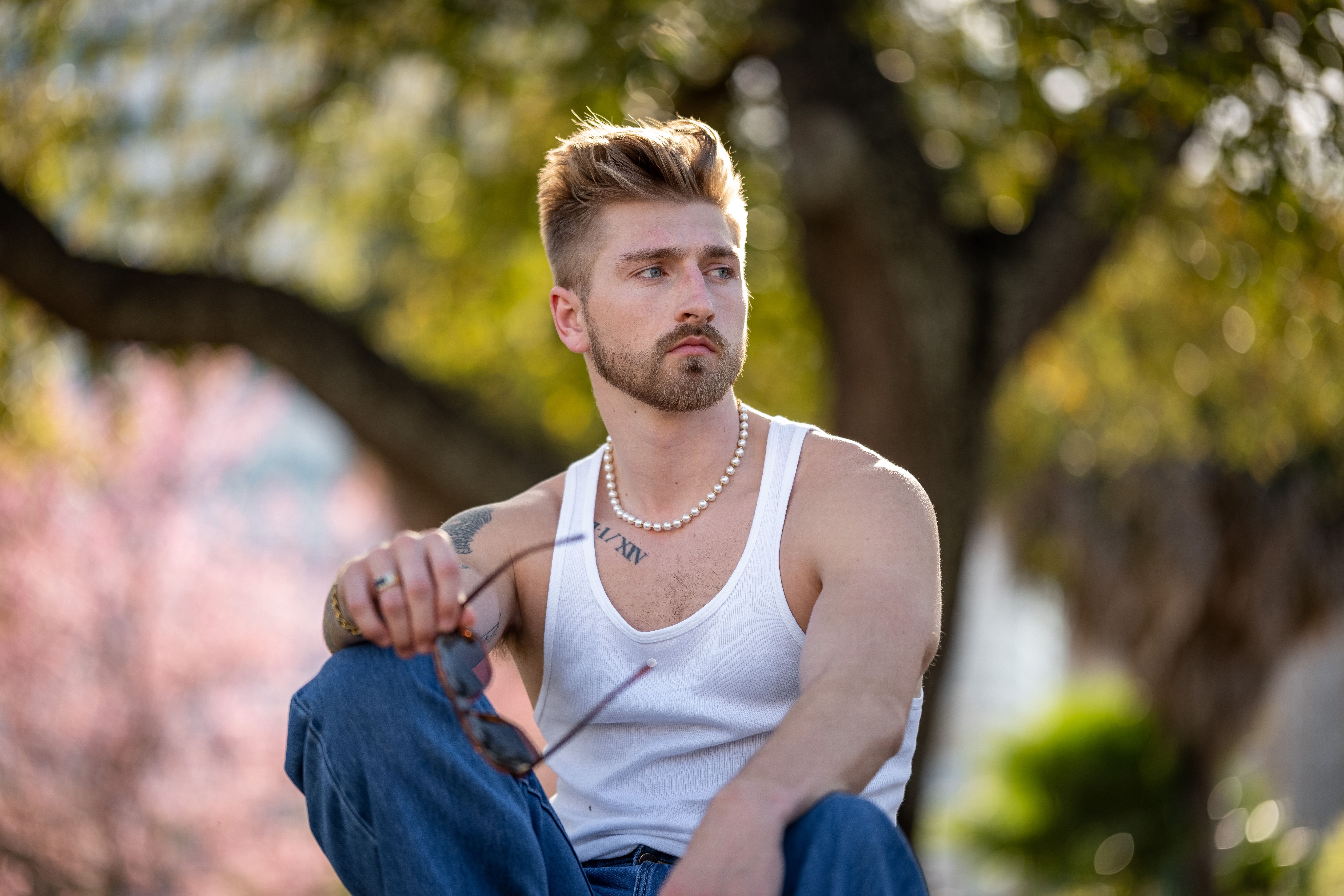 Sitting Man in Tank Top · Free Stock Photo