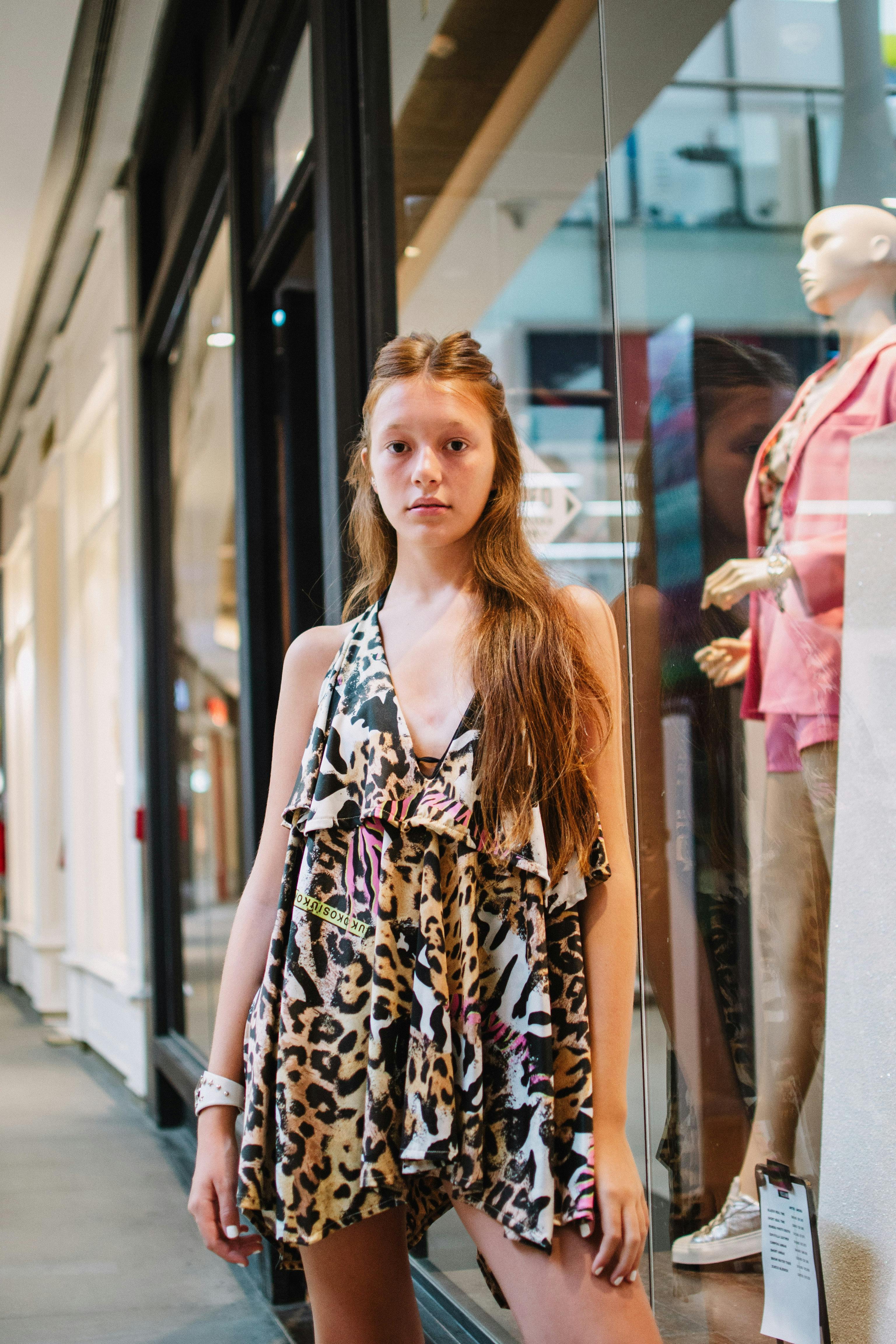 Woman Standing against Store Window Display · Free Stock Photo