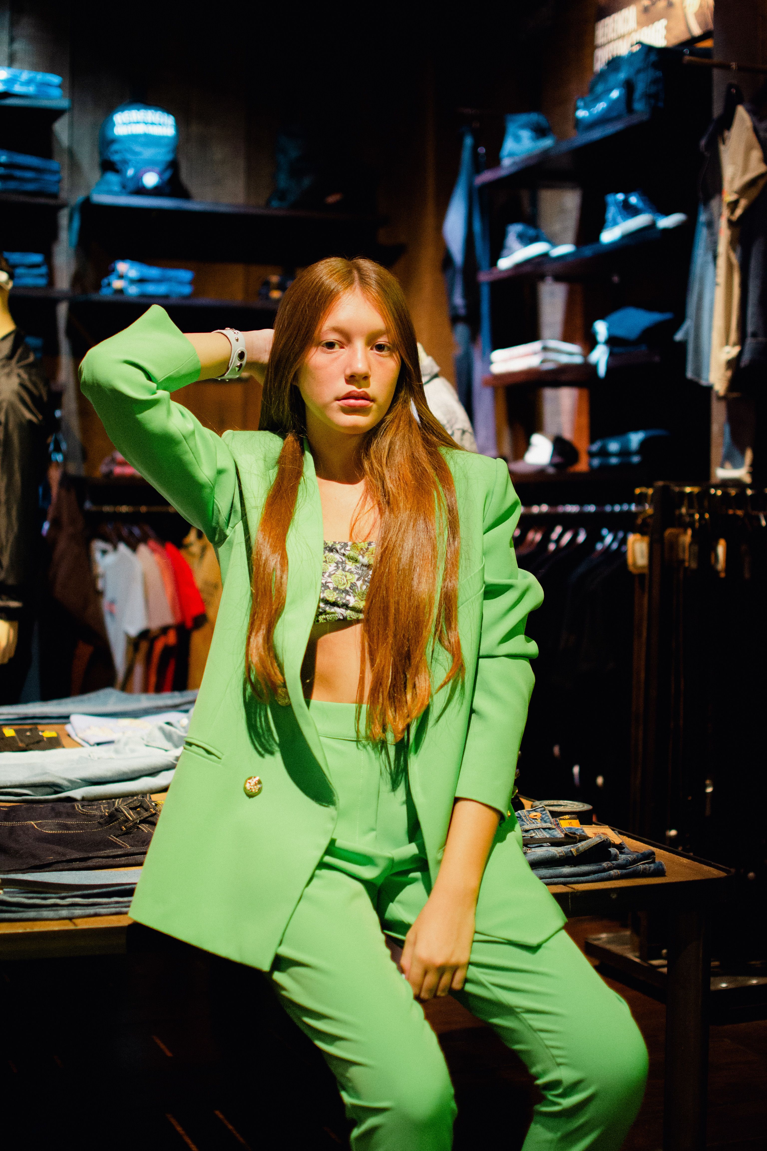 A Girl in a Trendy Outfit Posing in a Clothing Store · Free Stock Photo