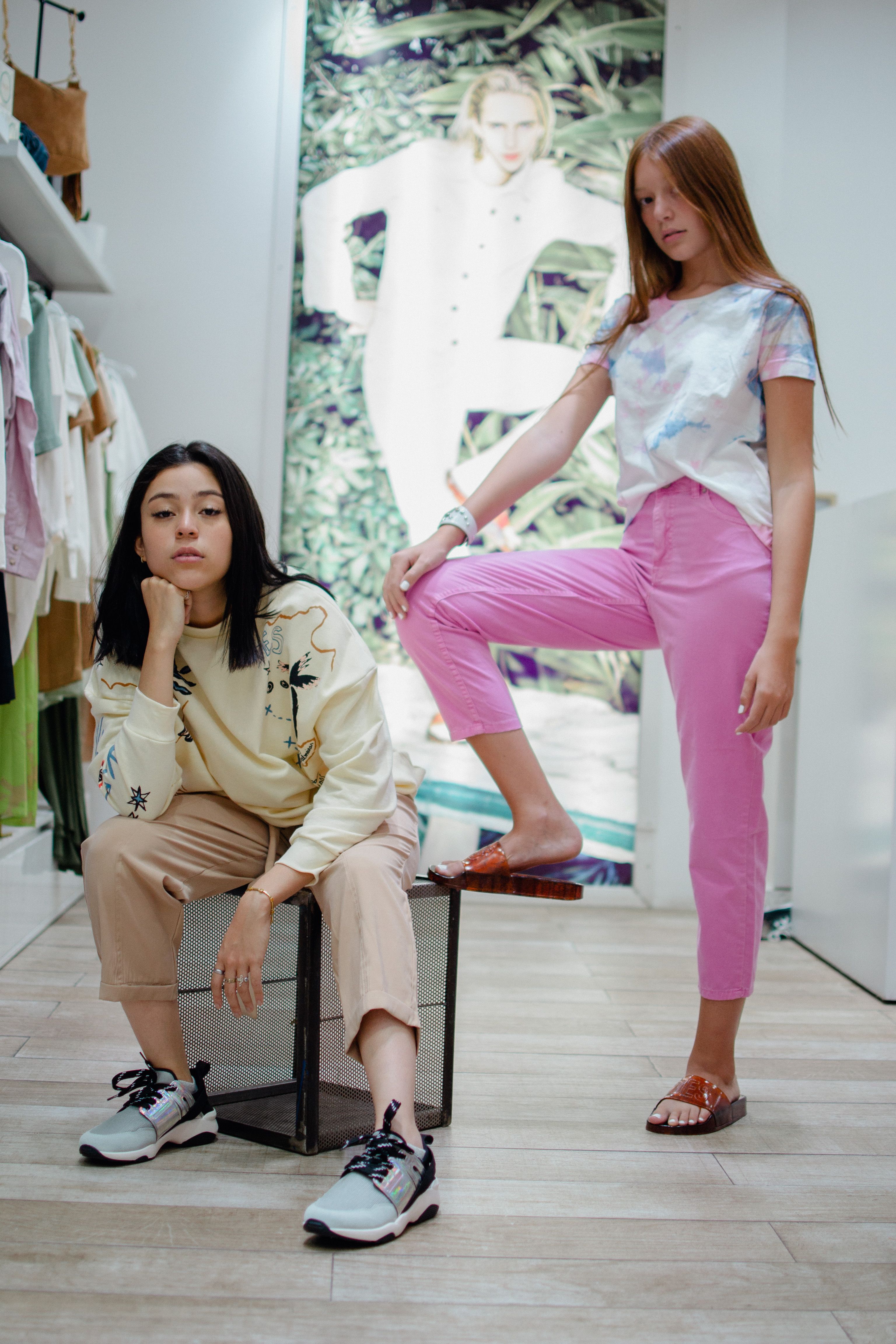 Young Women Posing in Clothing Store · Free Stock Photo