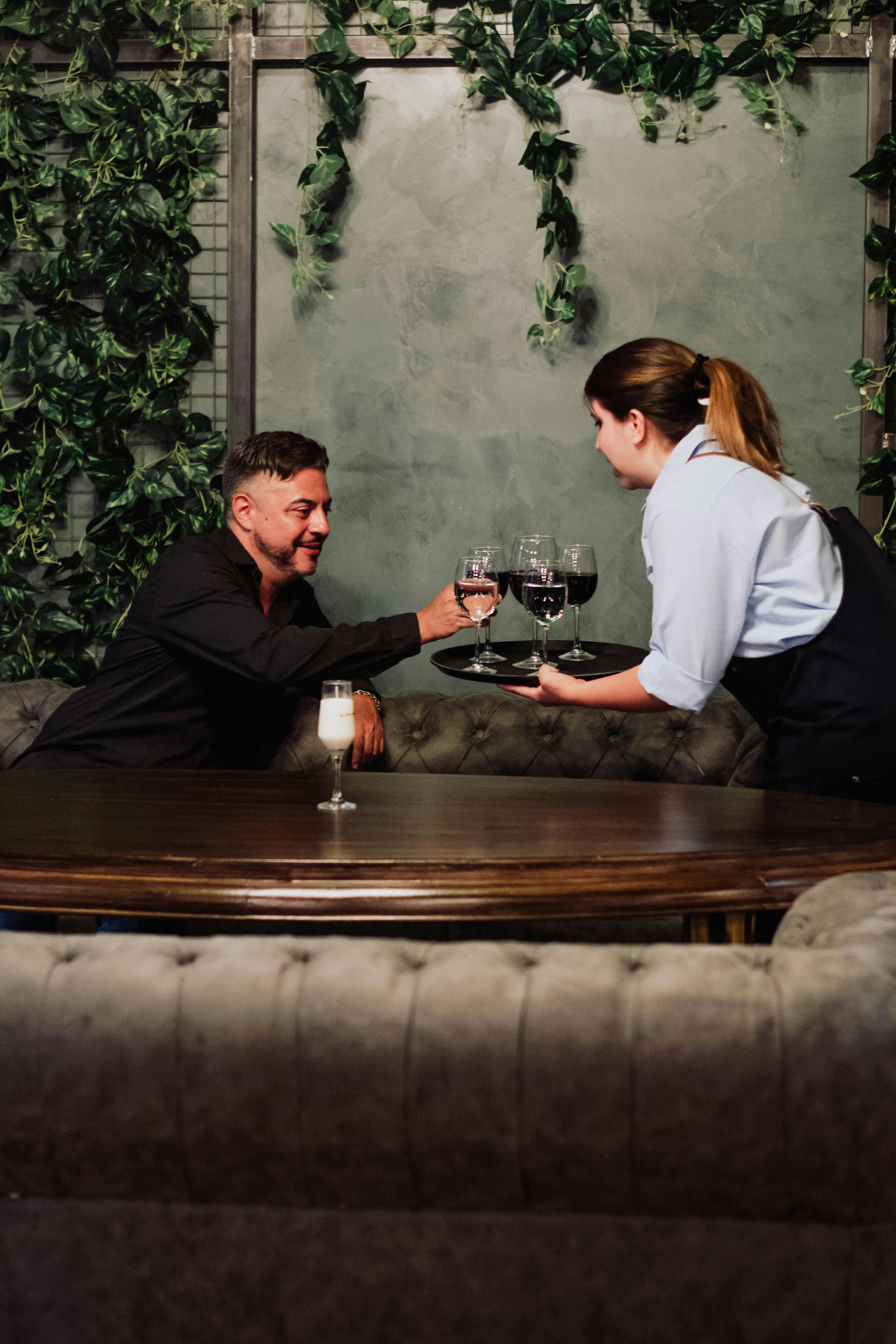 Customer Ordering Meal at Table in Restaurant · Free Stock Photo