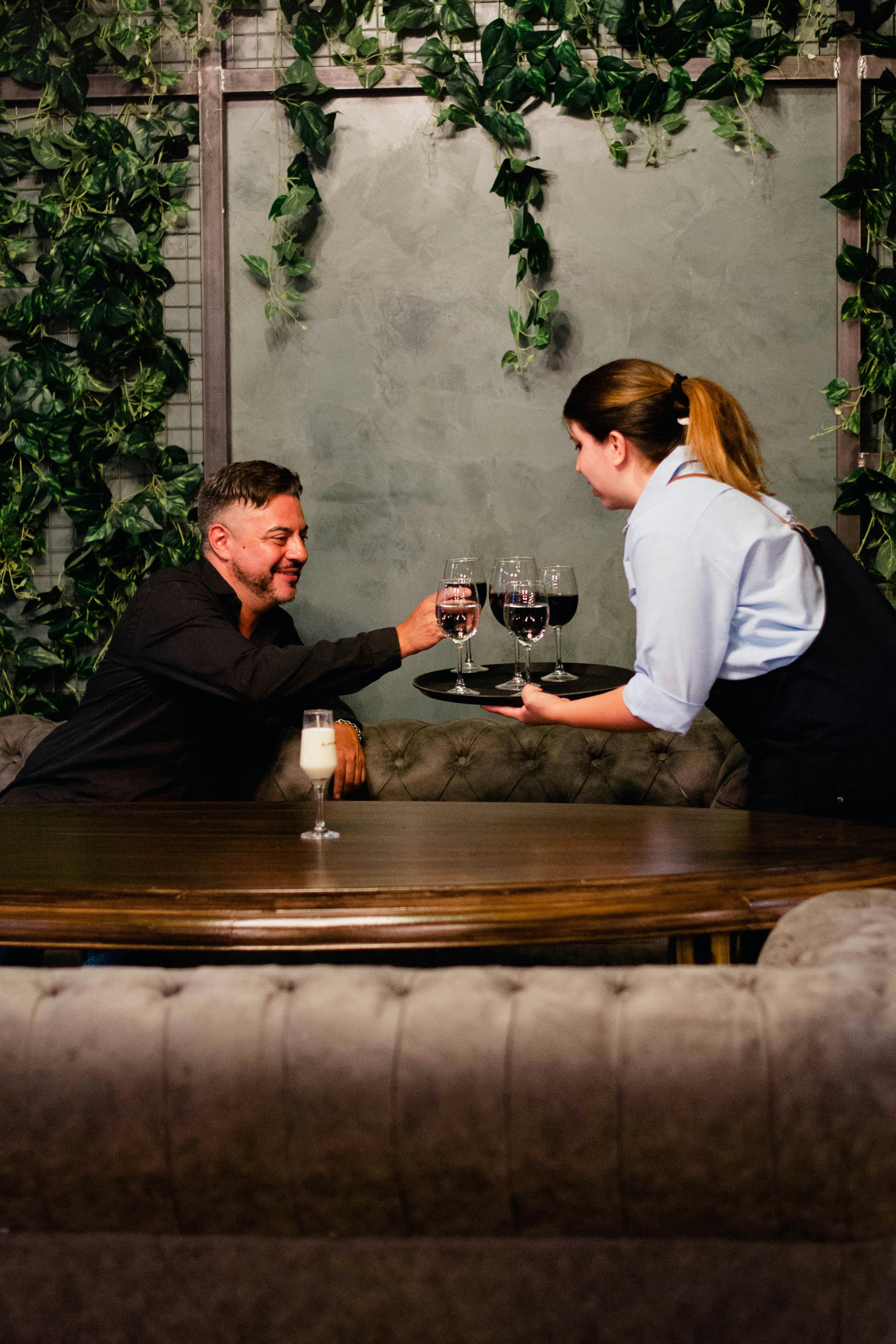 Waitress Serving Wine · Free Stock Photo